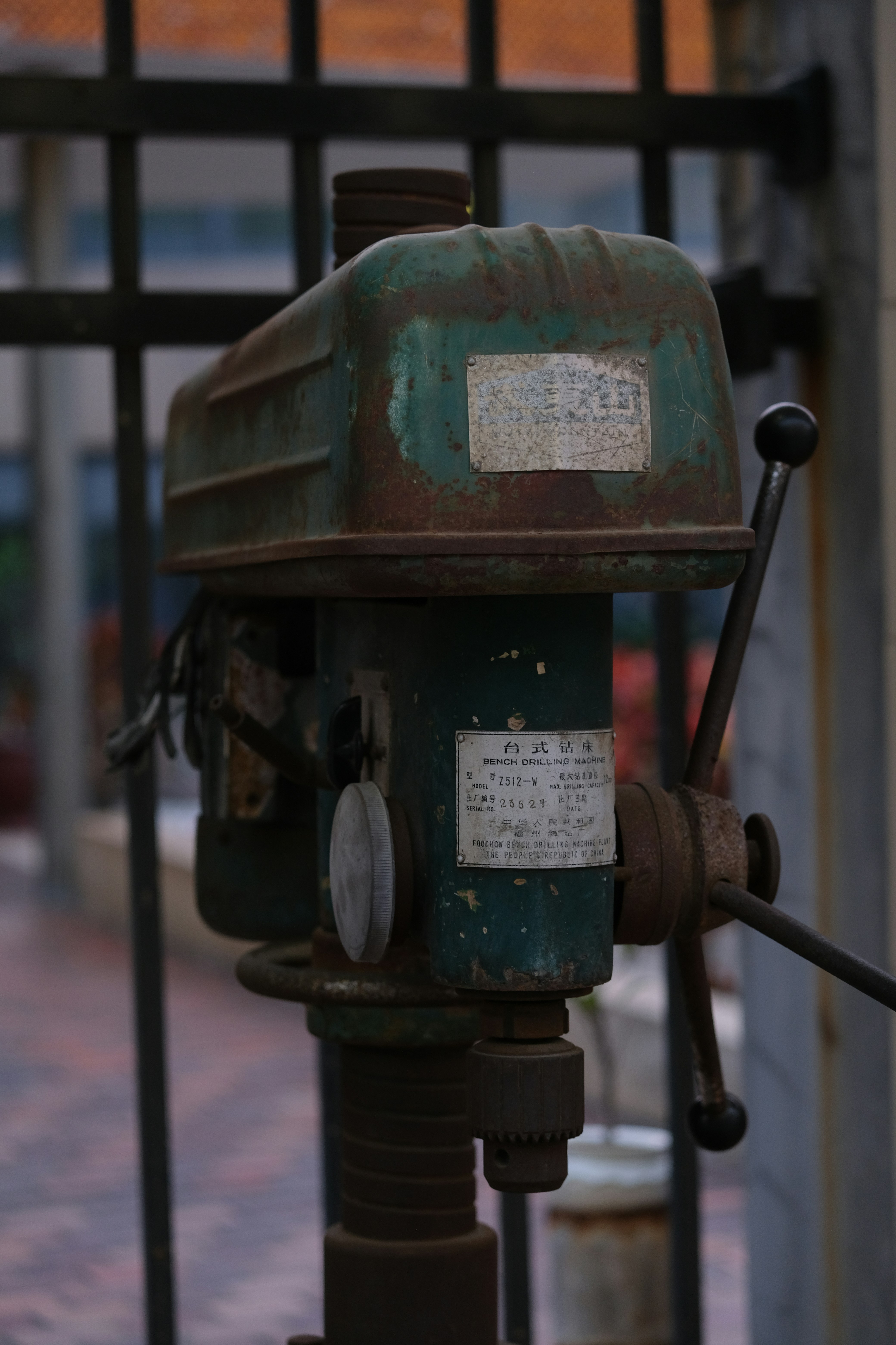 Rusty Mechanical Core: a close focus on a weathered device near iron bars