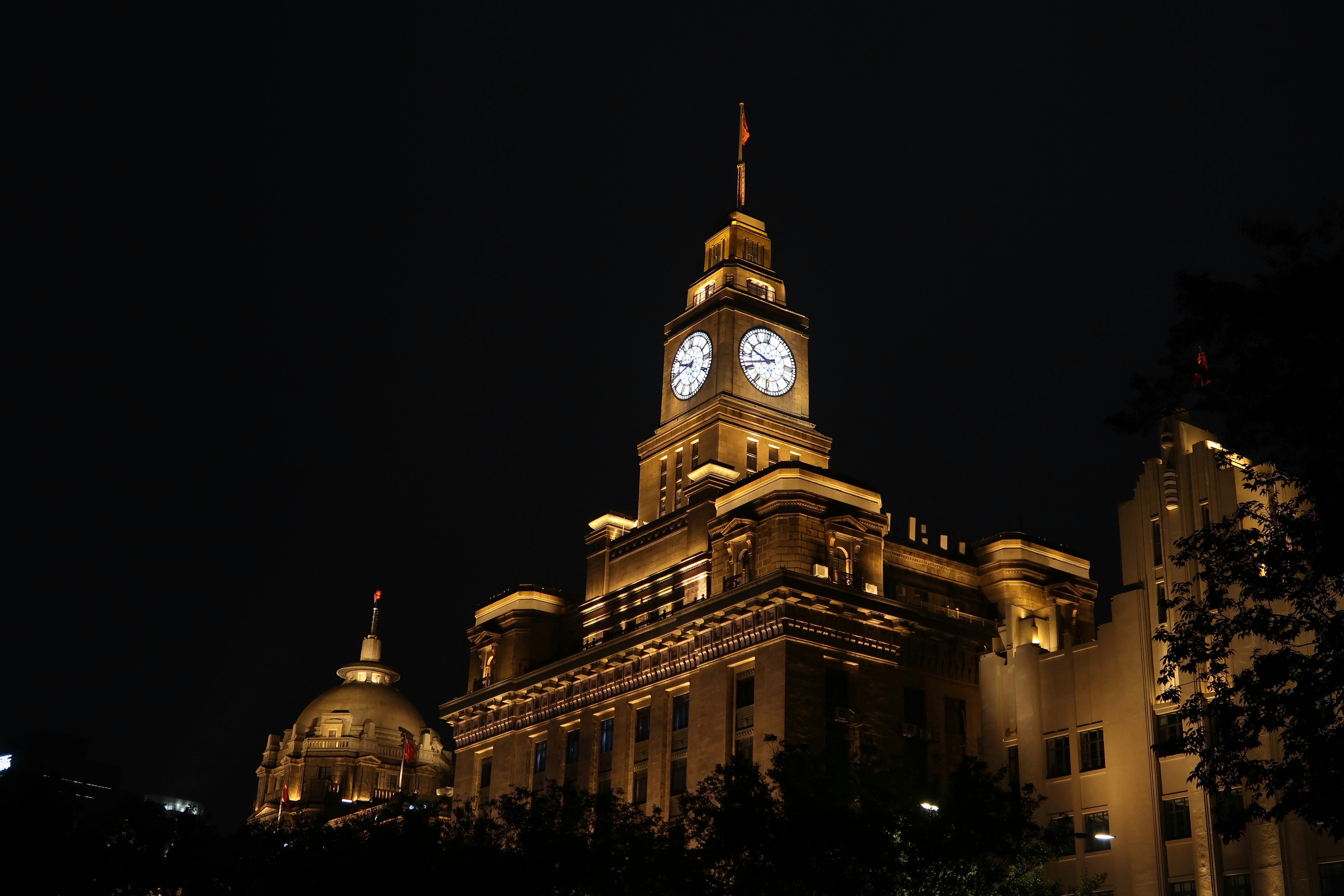 Midnight Clocktower: A Lit Facade Rising Over the Quiet Square