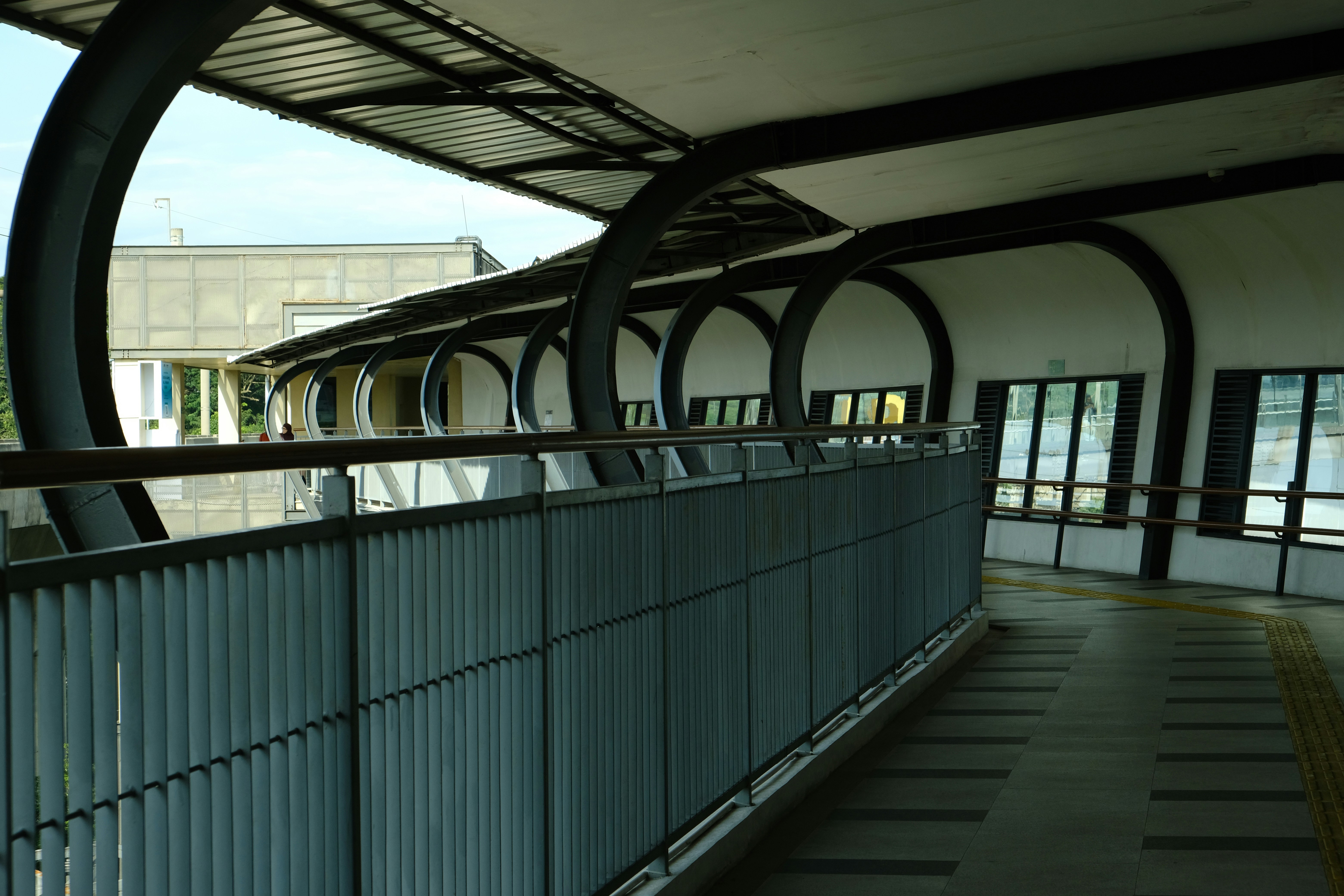 Curved Corridor Overlook: A Quiet Walkway into Light