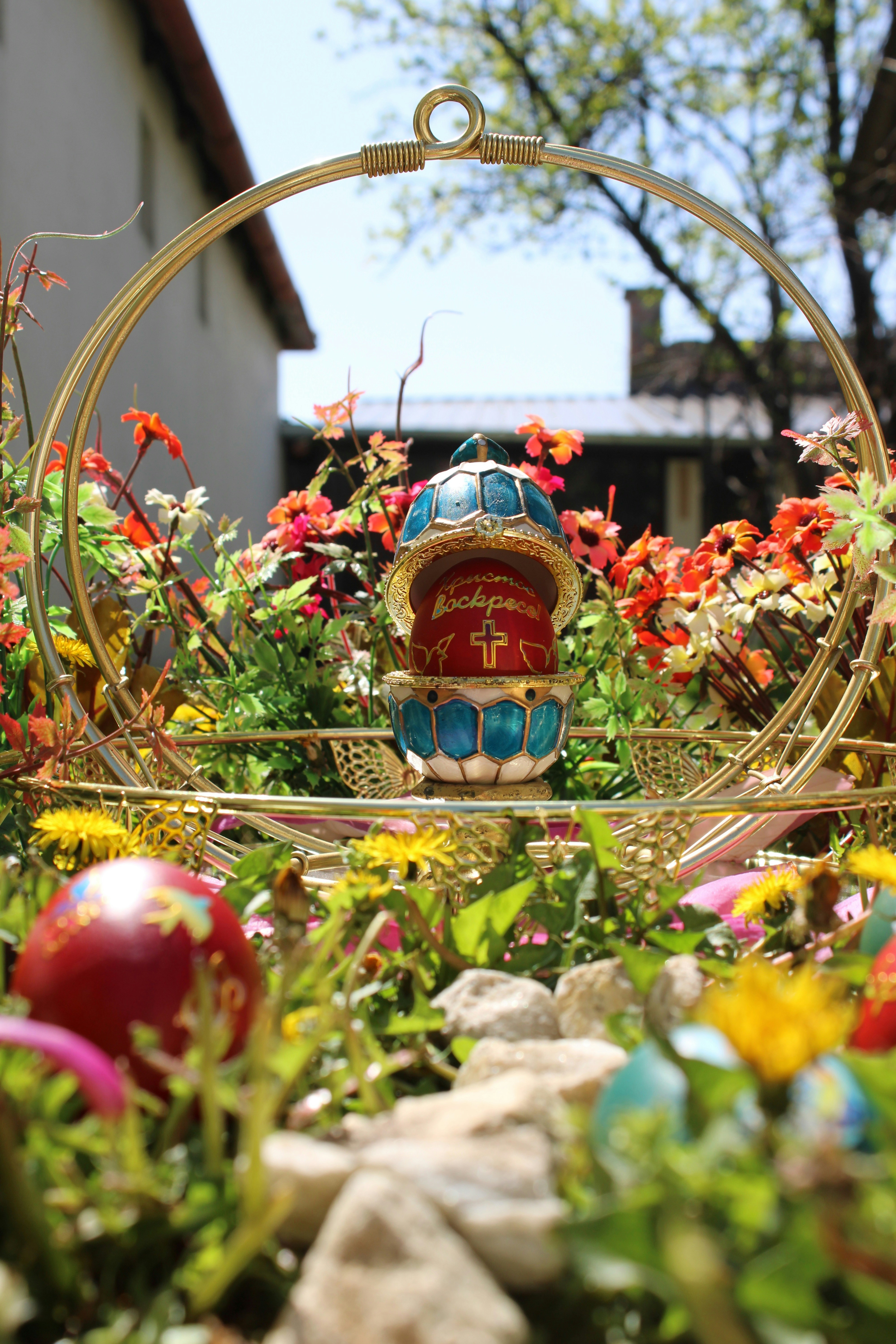 Ornamental Egg Crowned by Golden Ring in a Garden