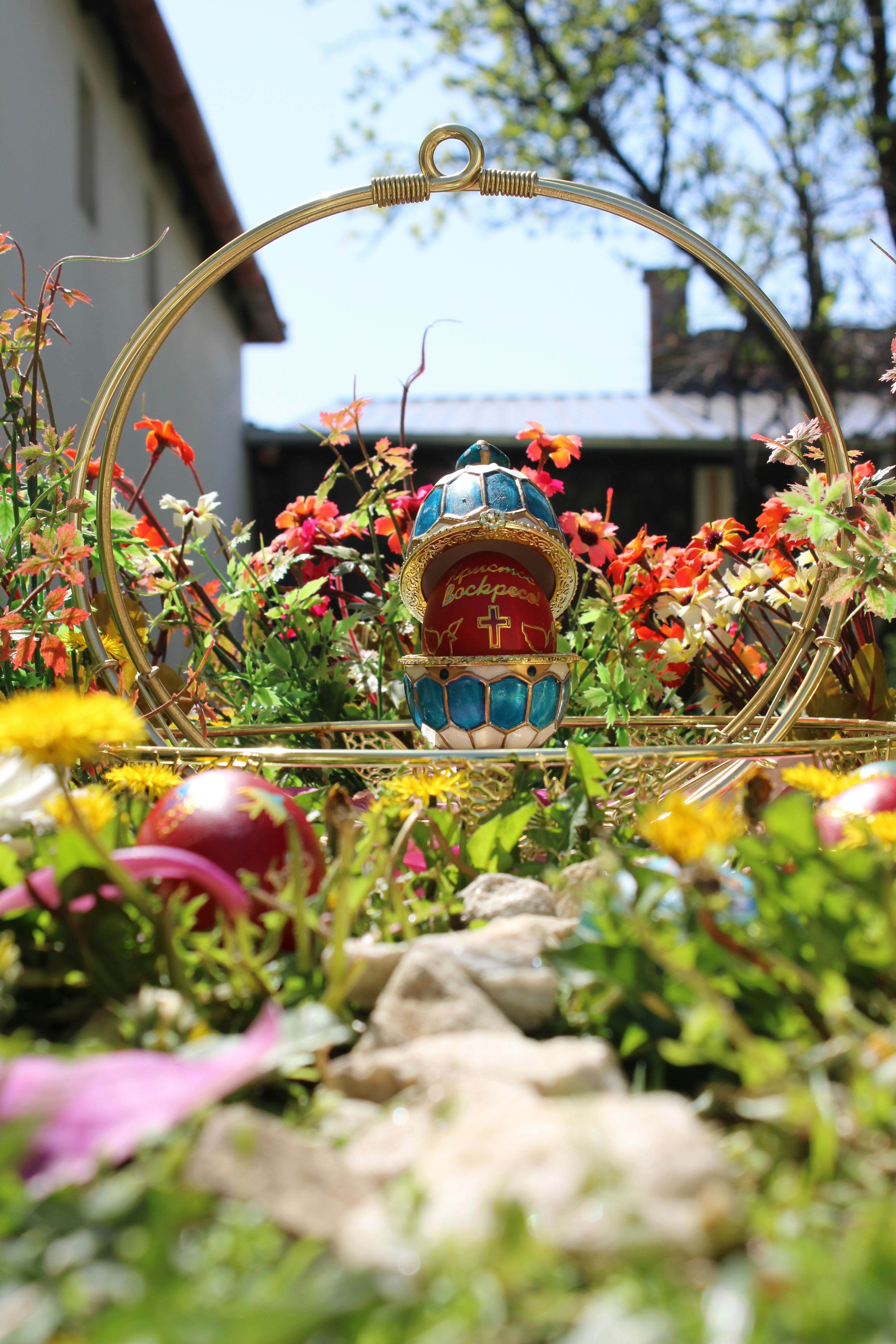 Colorful Egg Garden: A Glass-Encased Ornament Amid Spring Blossoms