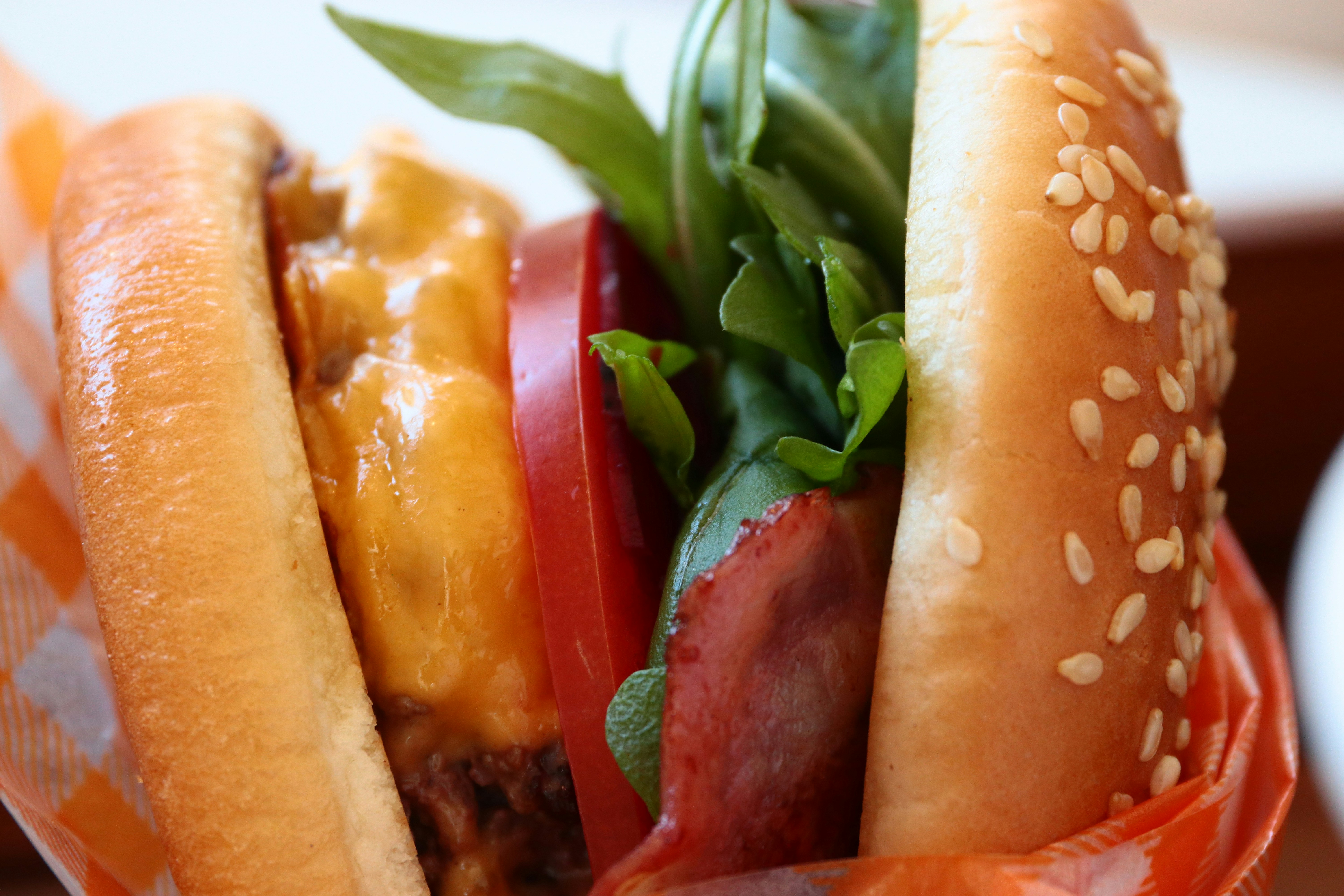 Close-Up of a Cheesy Burger Burst with Fresh Veggies
