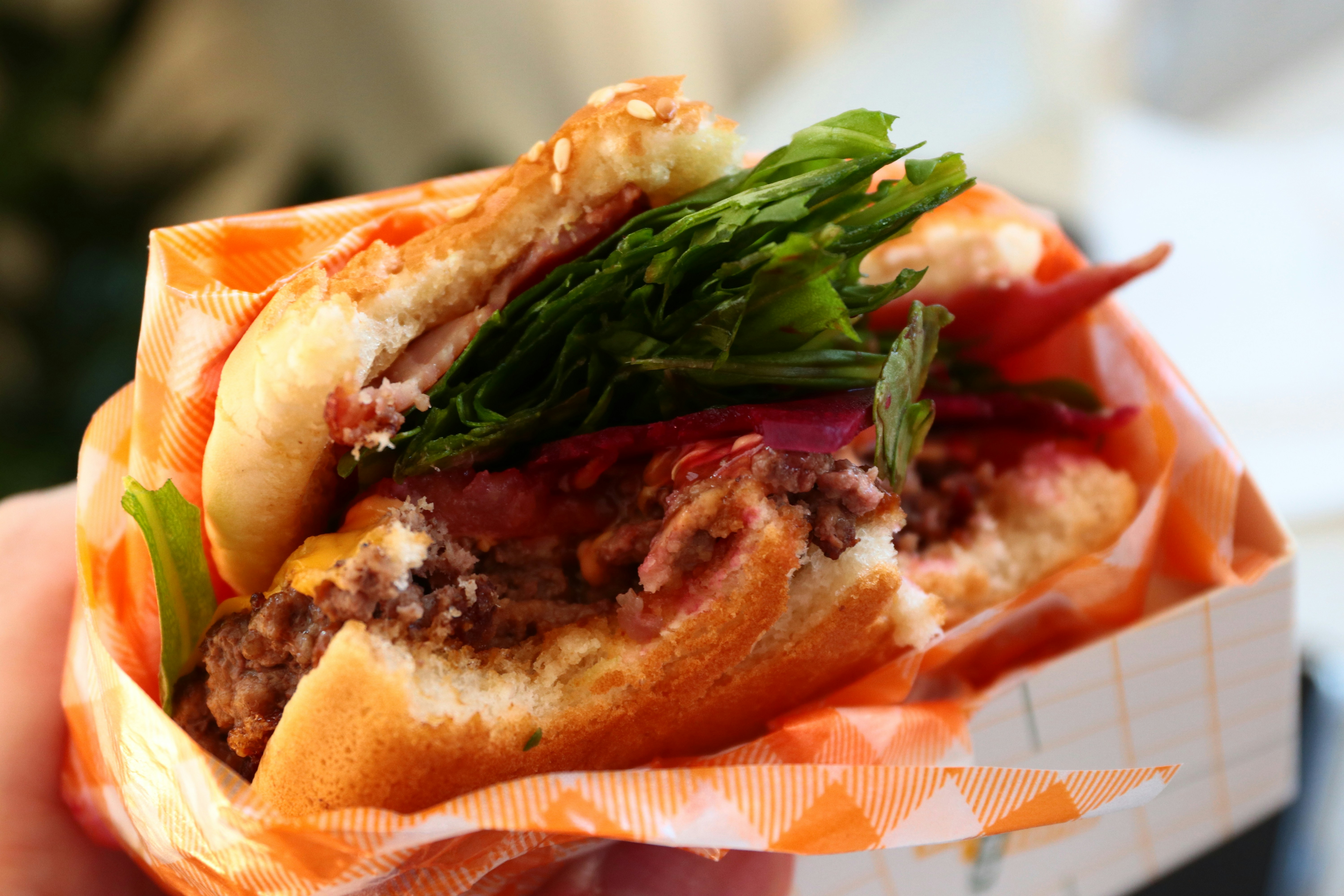 Juicy Crunch: A Loaded Fast-Casual Sandwich in Warm Orange Wrapper
