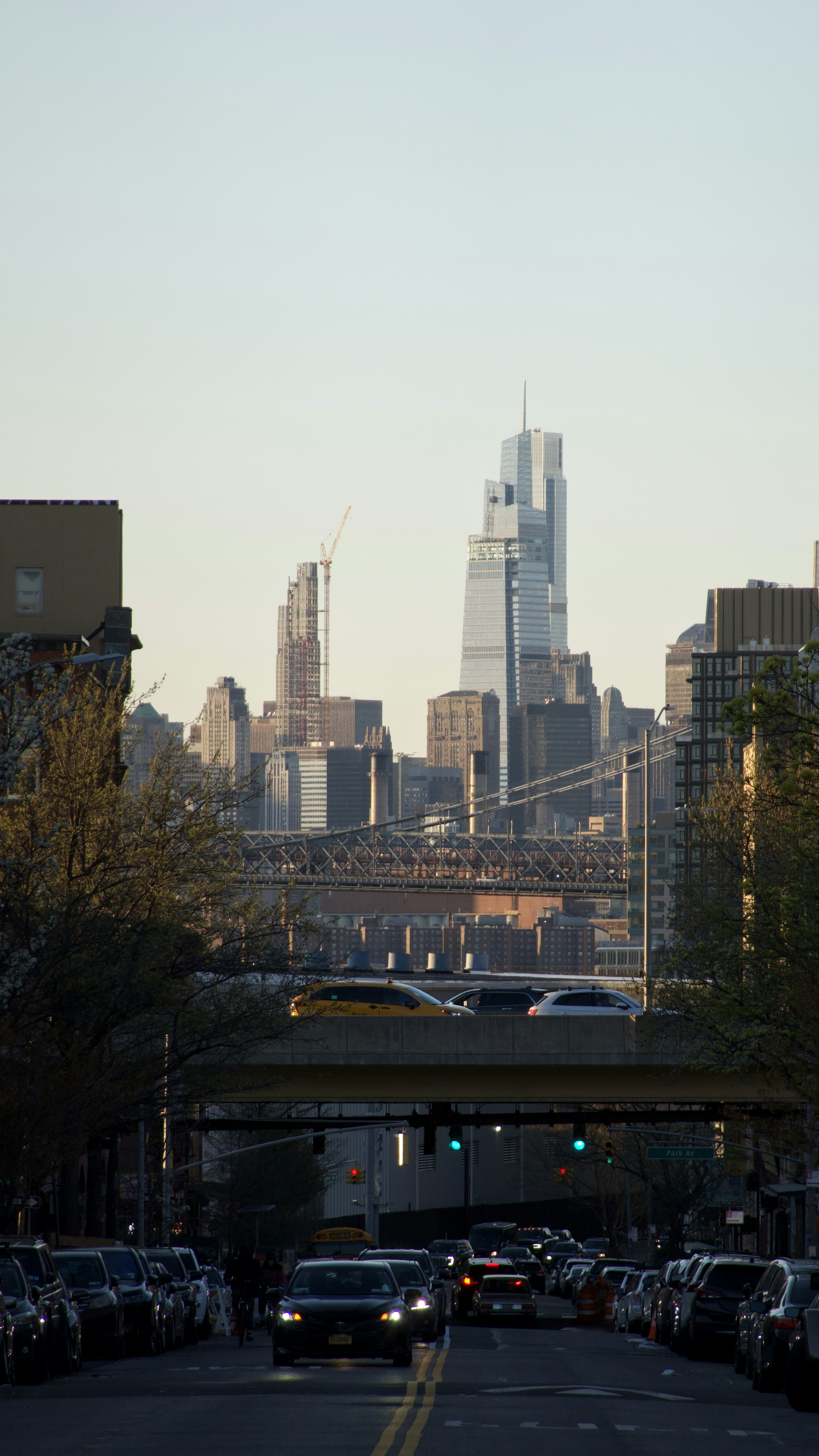 City skyline with traffic on a street at sunset.