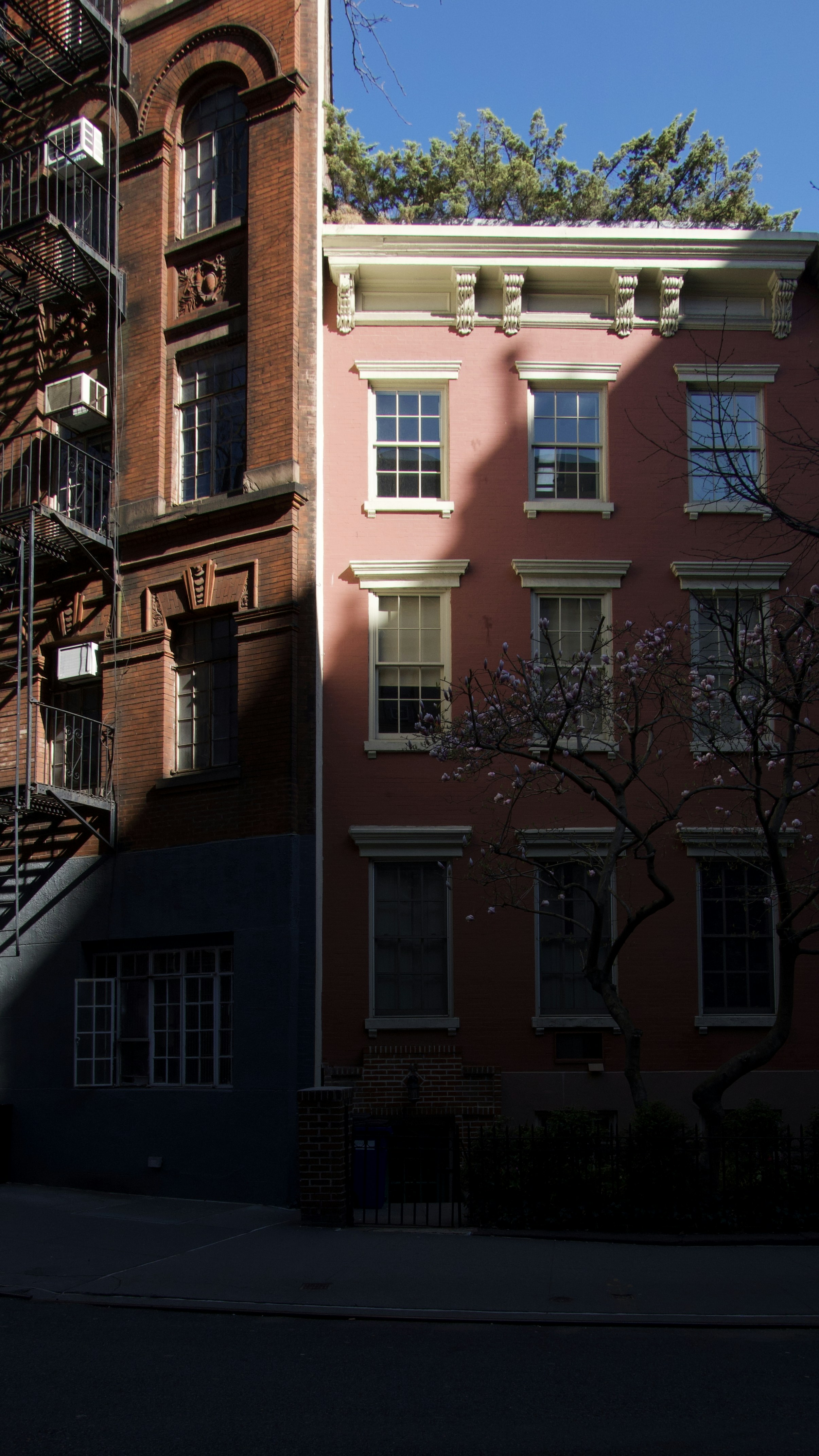 Sunlit Pink Facade: A Quiet Alley Portrait