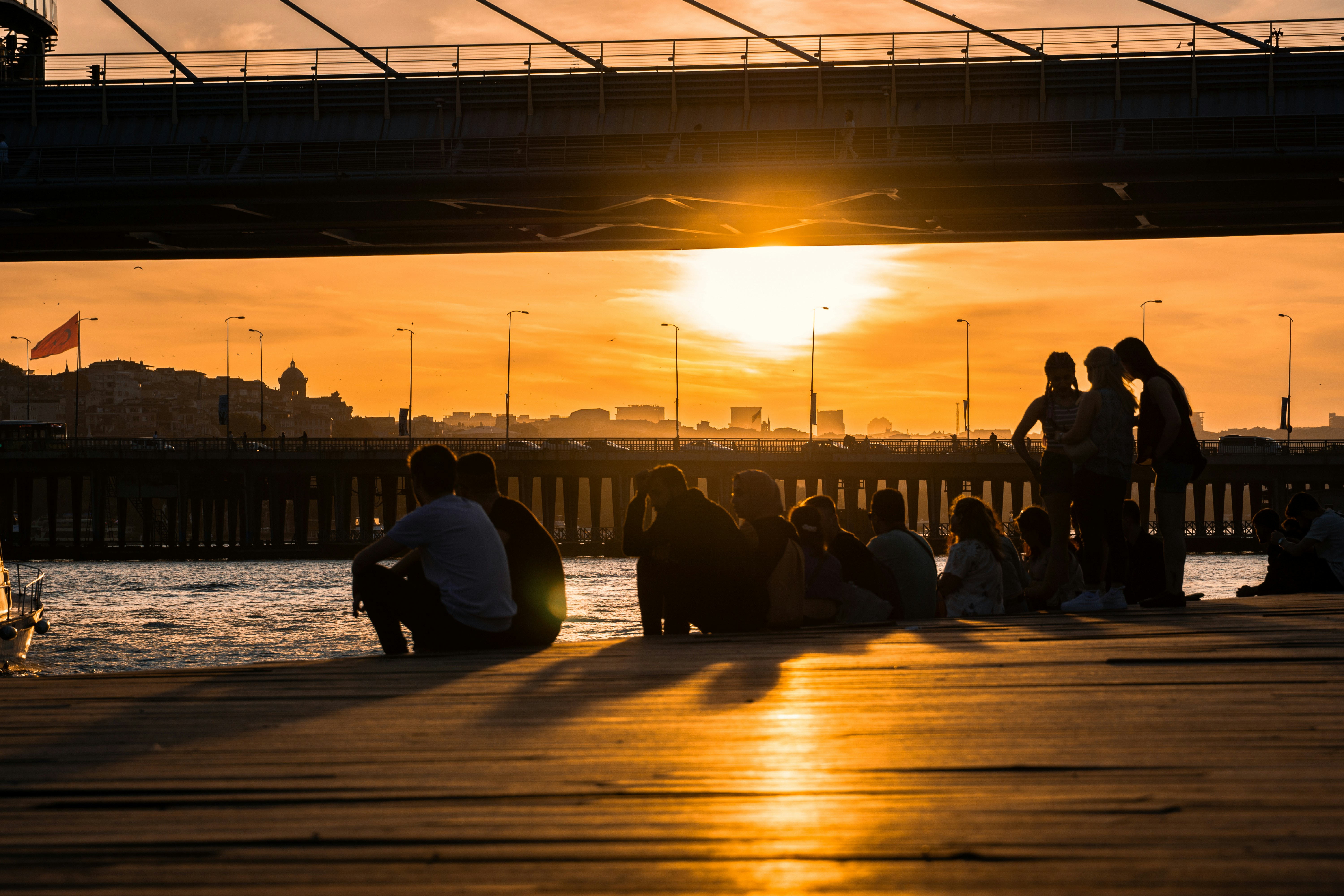 Sunset by the Pier: silhouettes and warm glow on the boardwalk