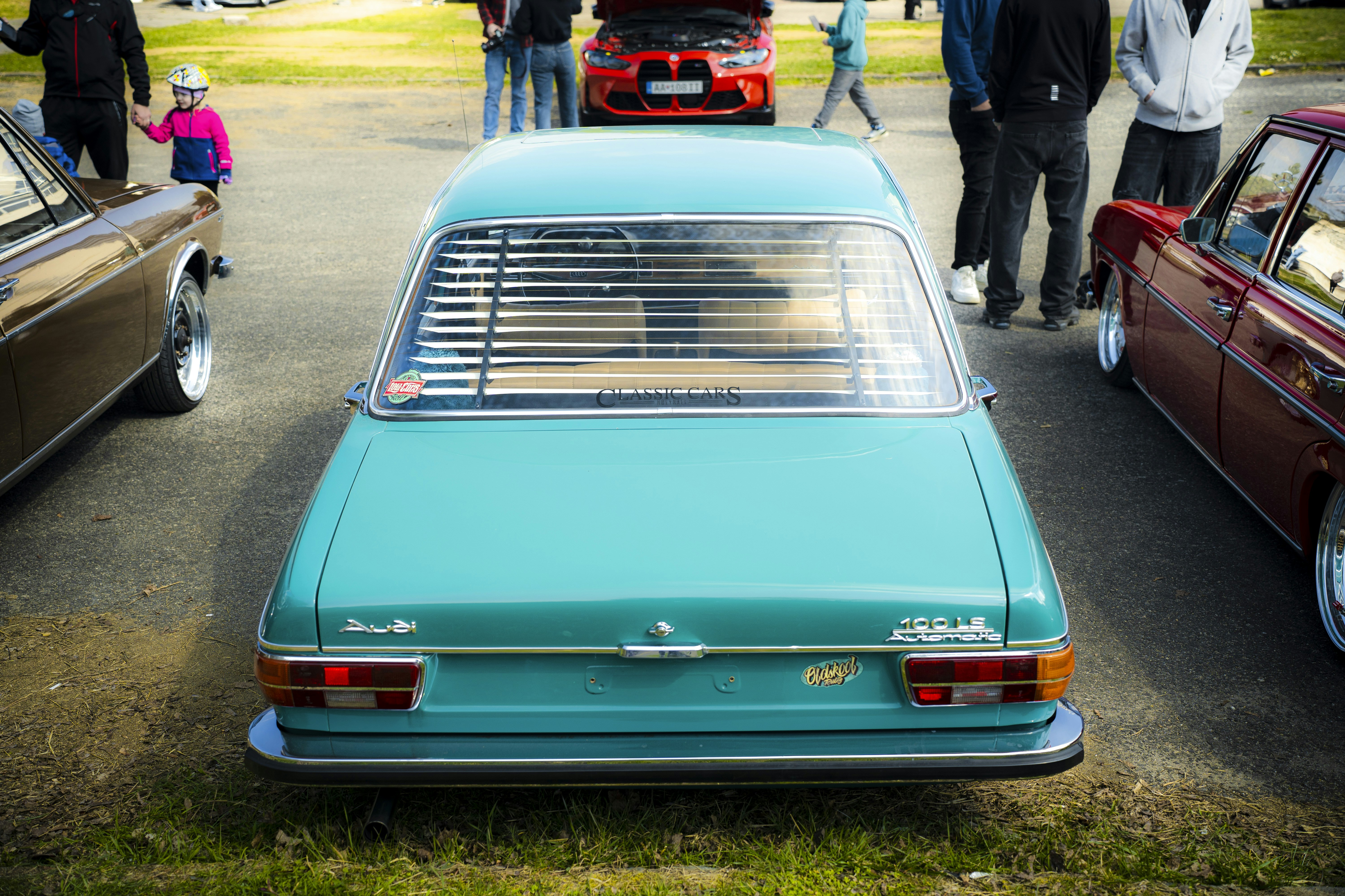 Turquoise Classic in the Park: Rear View of a Vintage Car Parade