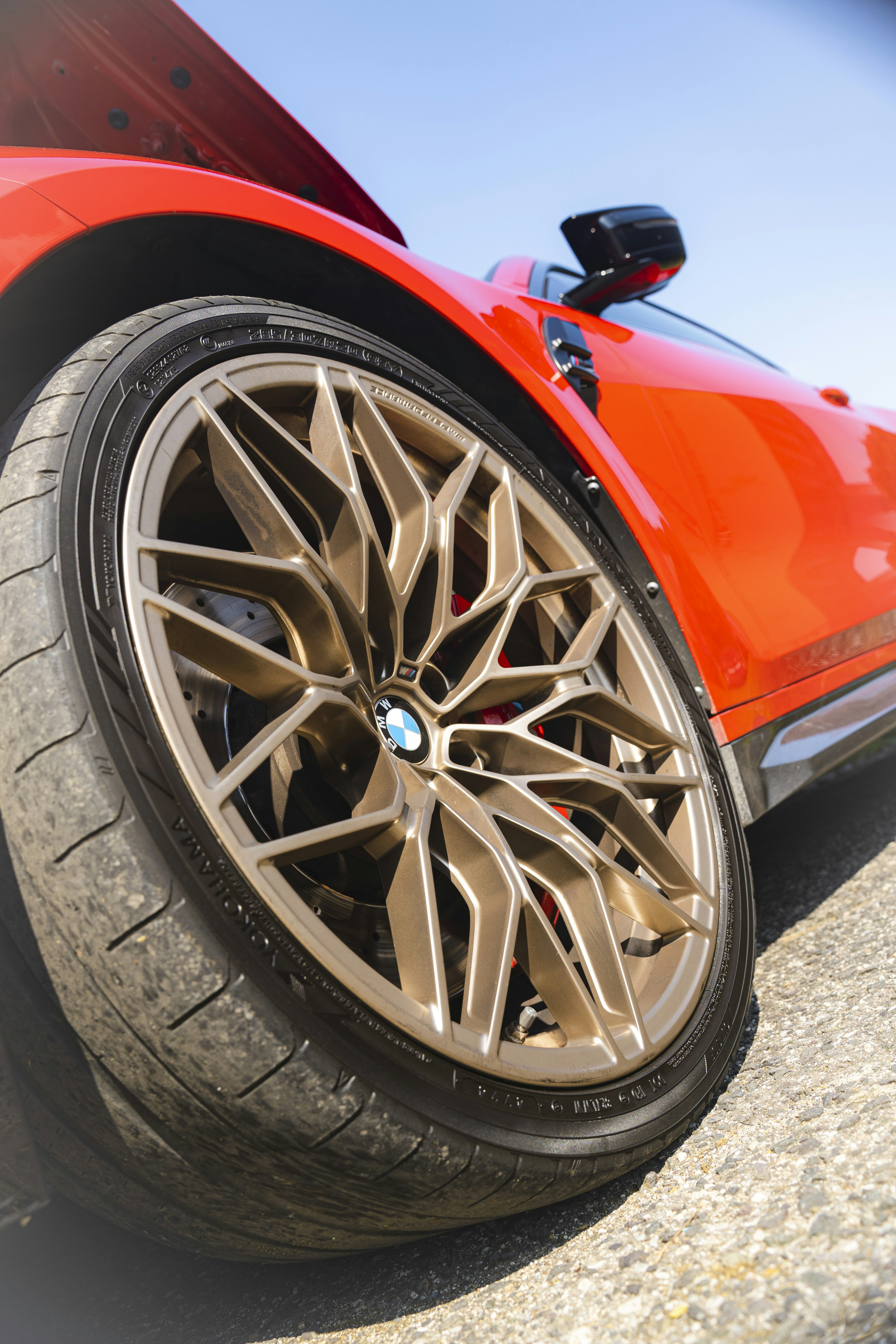 Bronze wheel spirals under a blazing red hood