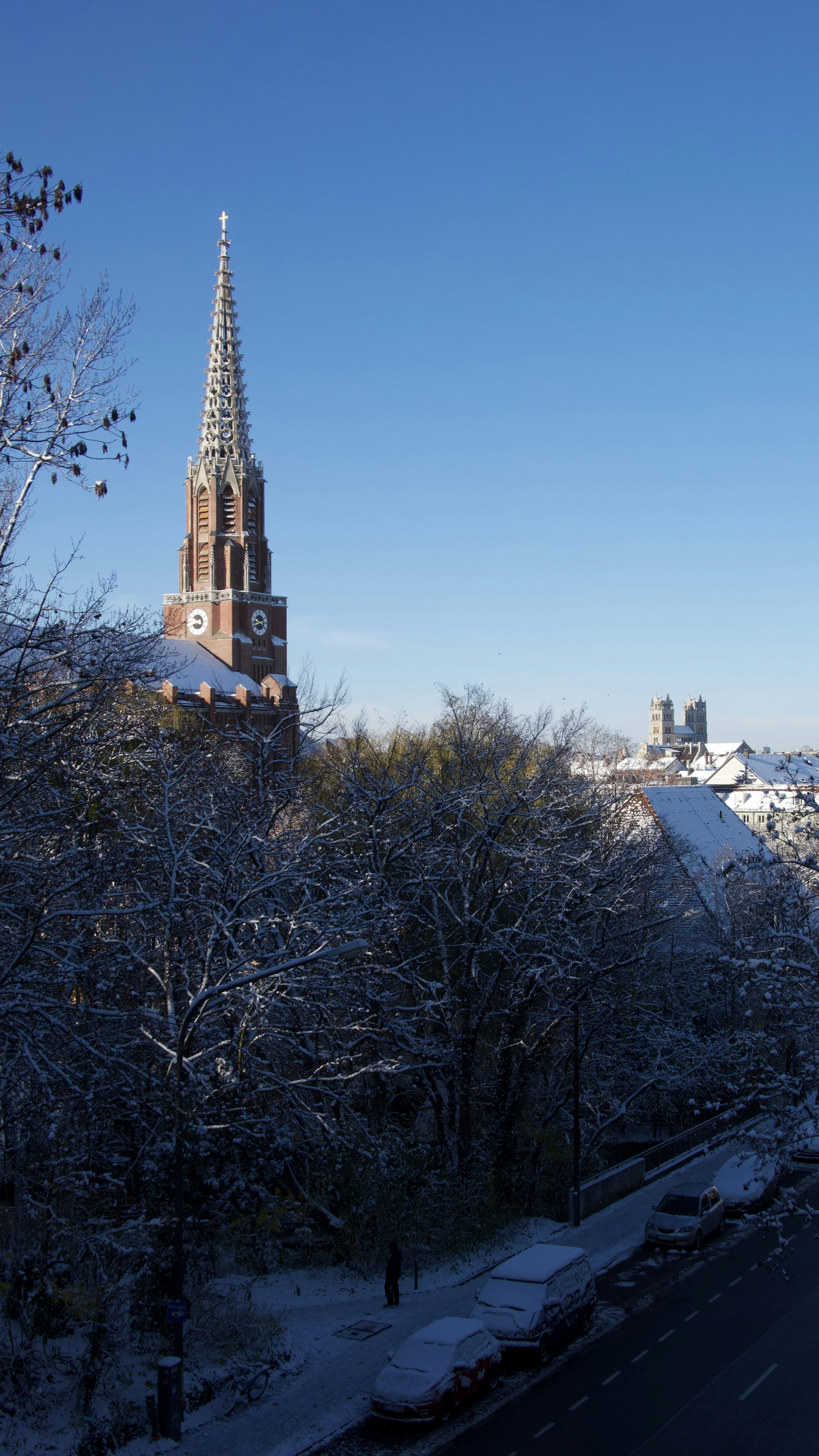 Winter Cathedral: Snow-Caped Spire Rising Over Quiet Street