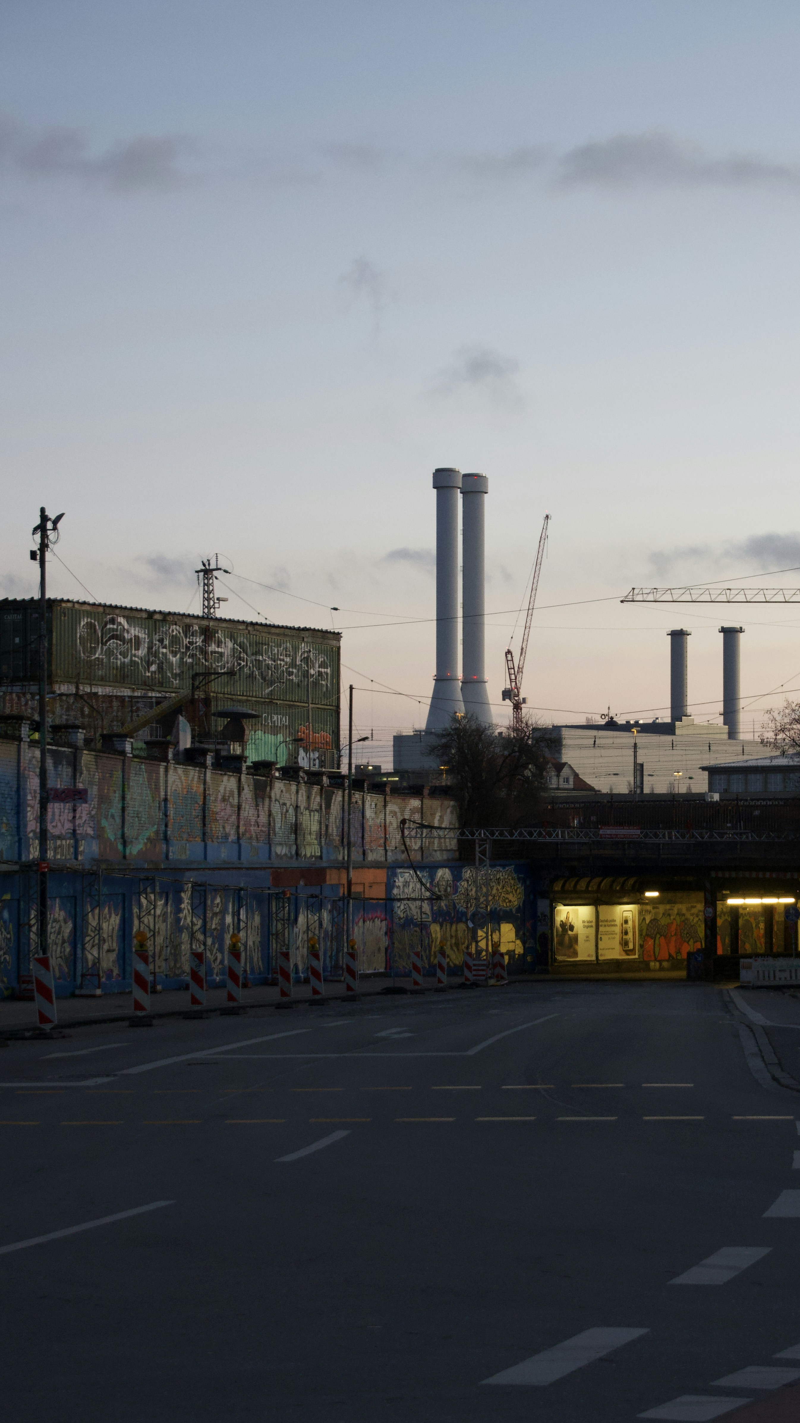 Industrial Twilight: Street and Smokestacks Framing a City Edge