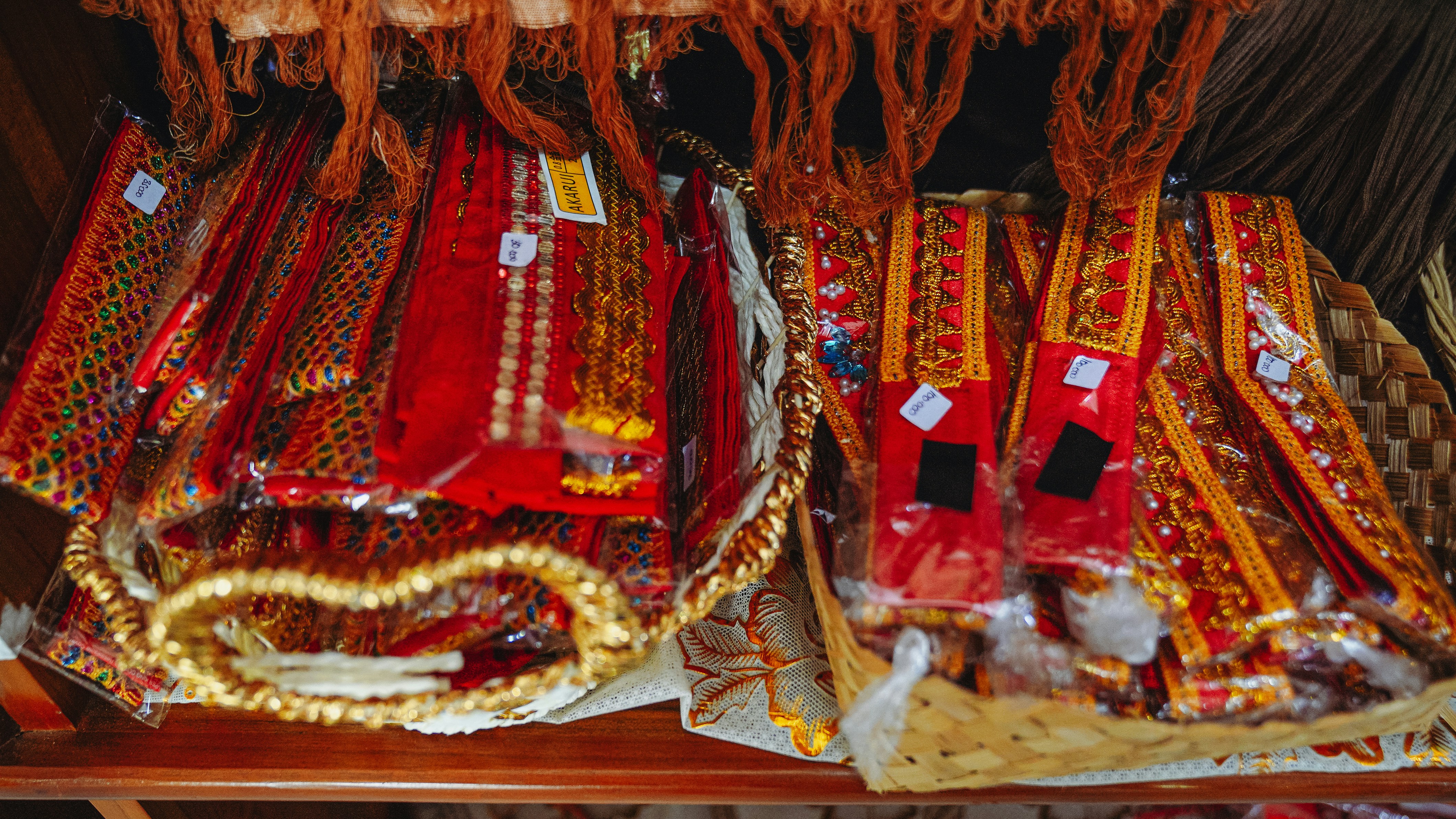 Vibrant Textile Market: Ornate Red Ribbons and Embroidered Fabrics