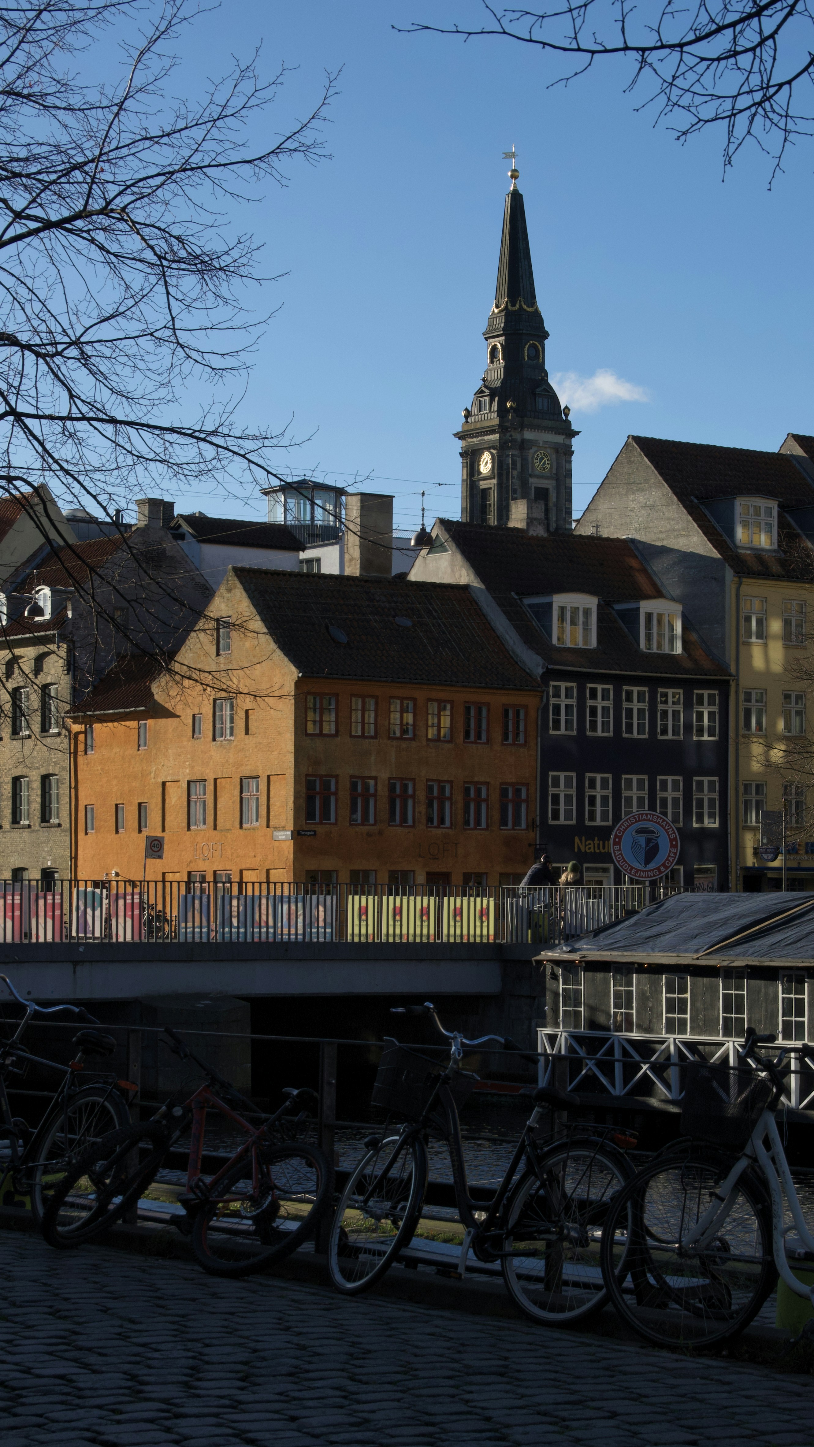 Harbor Town Palettes: Distant Church Spire Over Colorful Riverside Buildings