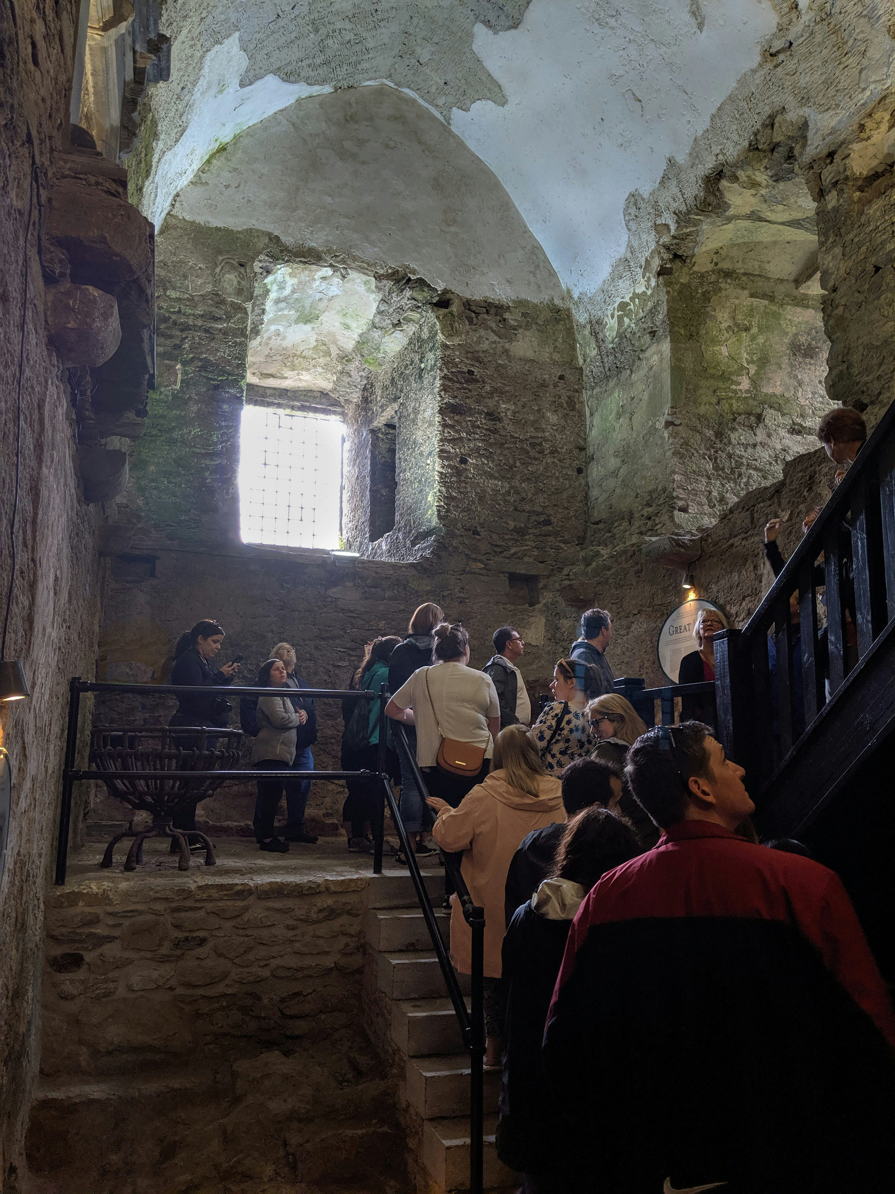 Stone Staircase Echoes: A Line of Visitors in an Ancient Hall