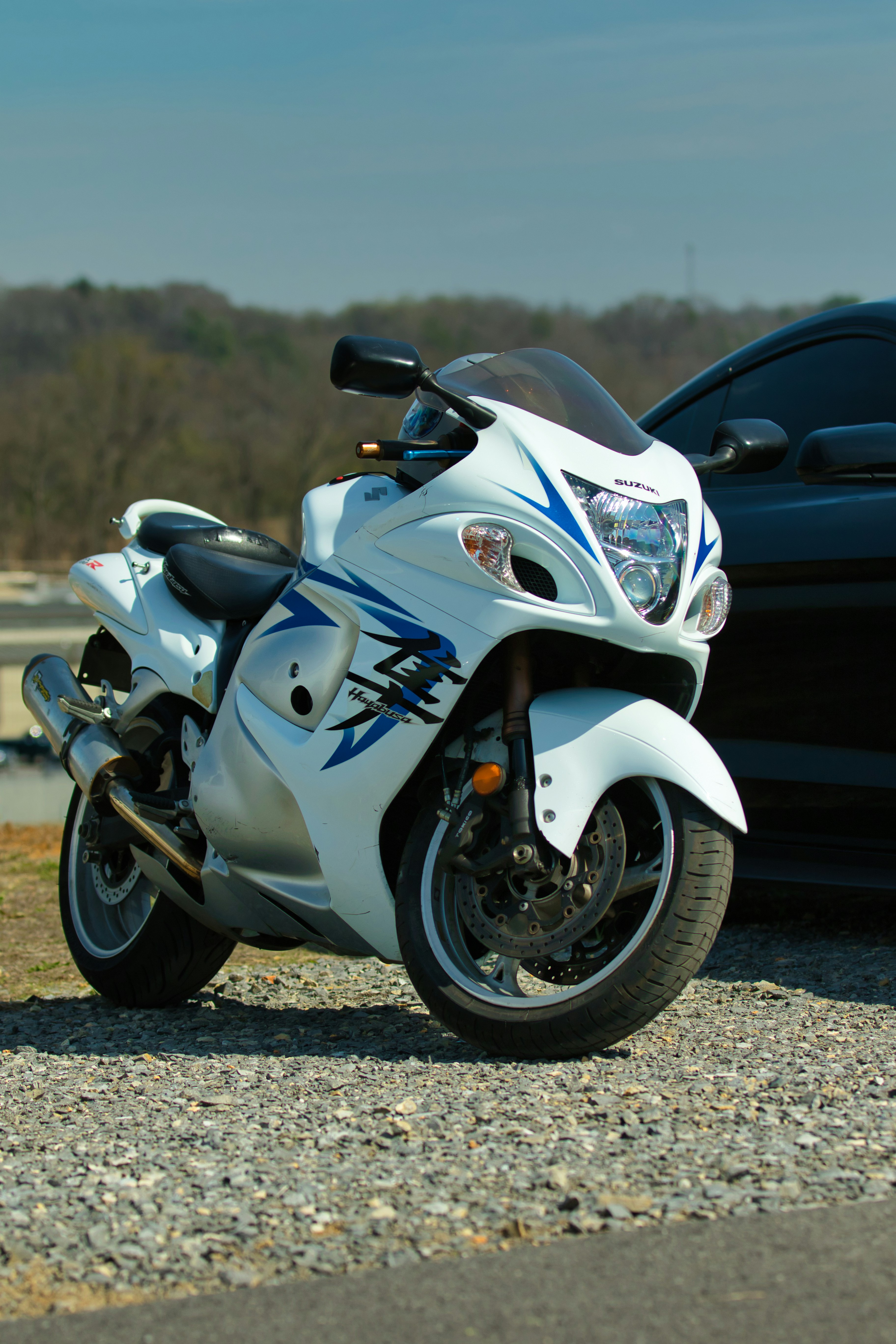 White sportbike at roadside, chrome accents catching the sun