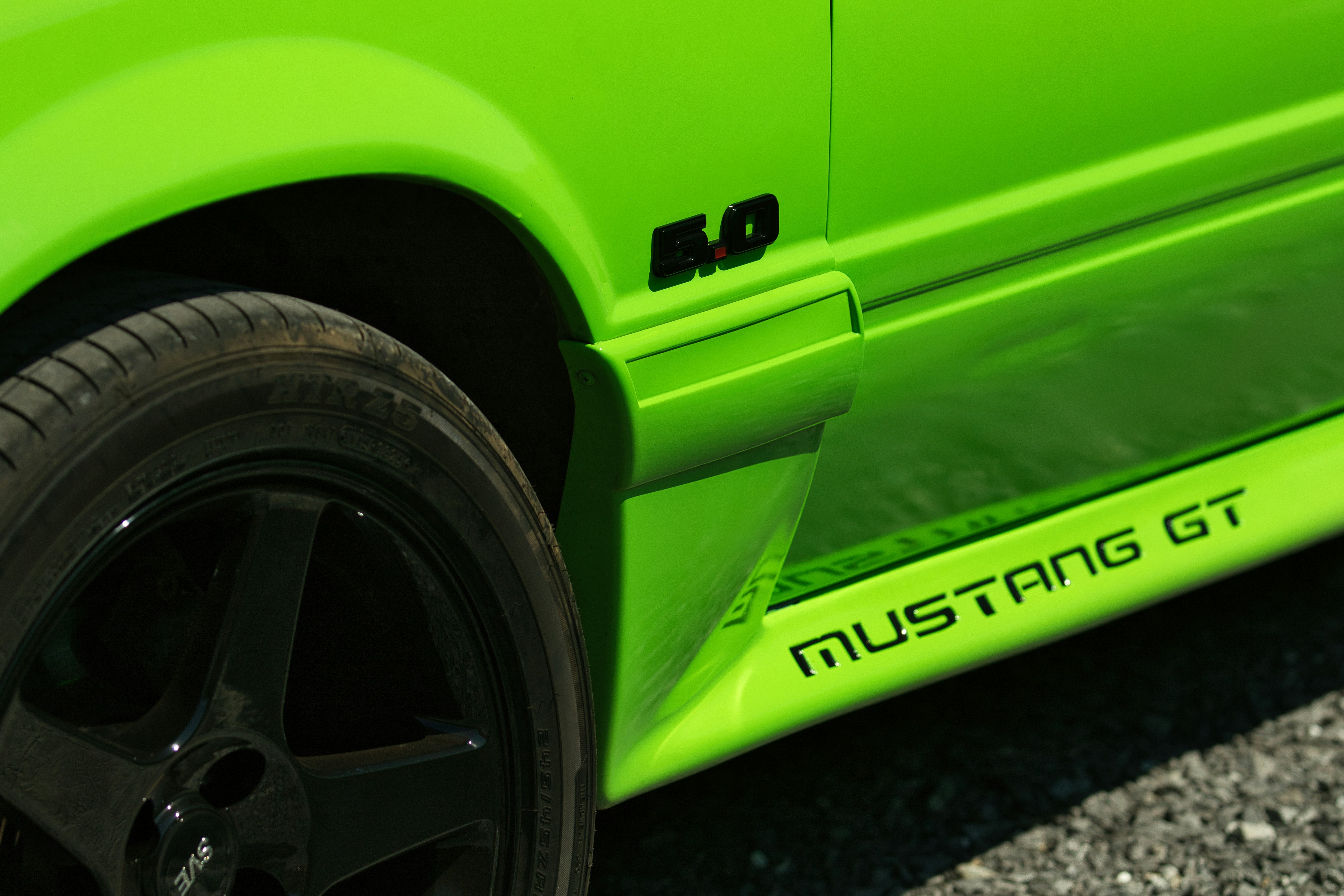 Volt Green: A Mustang GT by the Wheel in Noon Sun