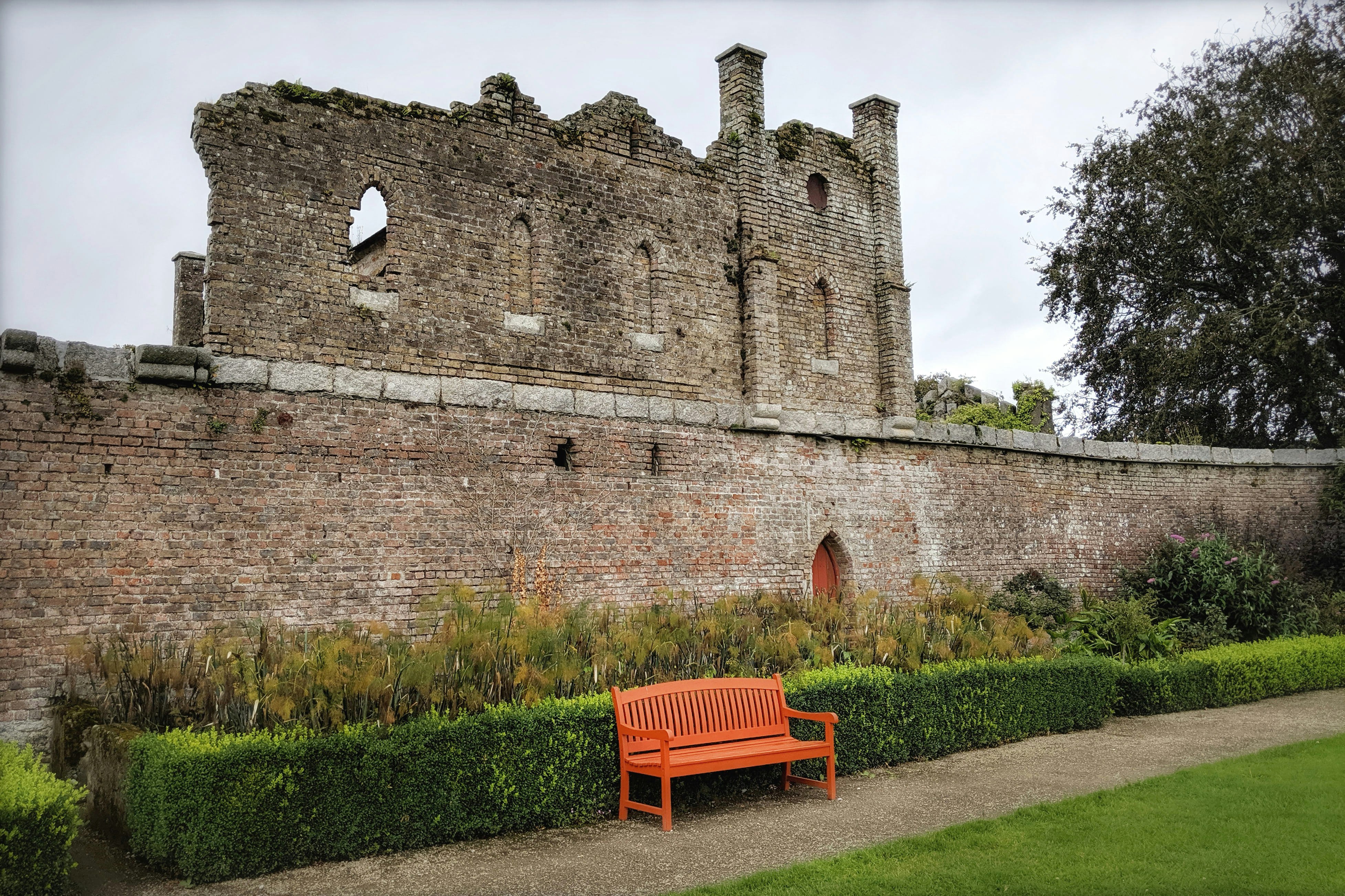 Ruined Keep Overlook: An Orange Seat Framing a Timeless Courtyard