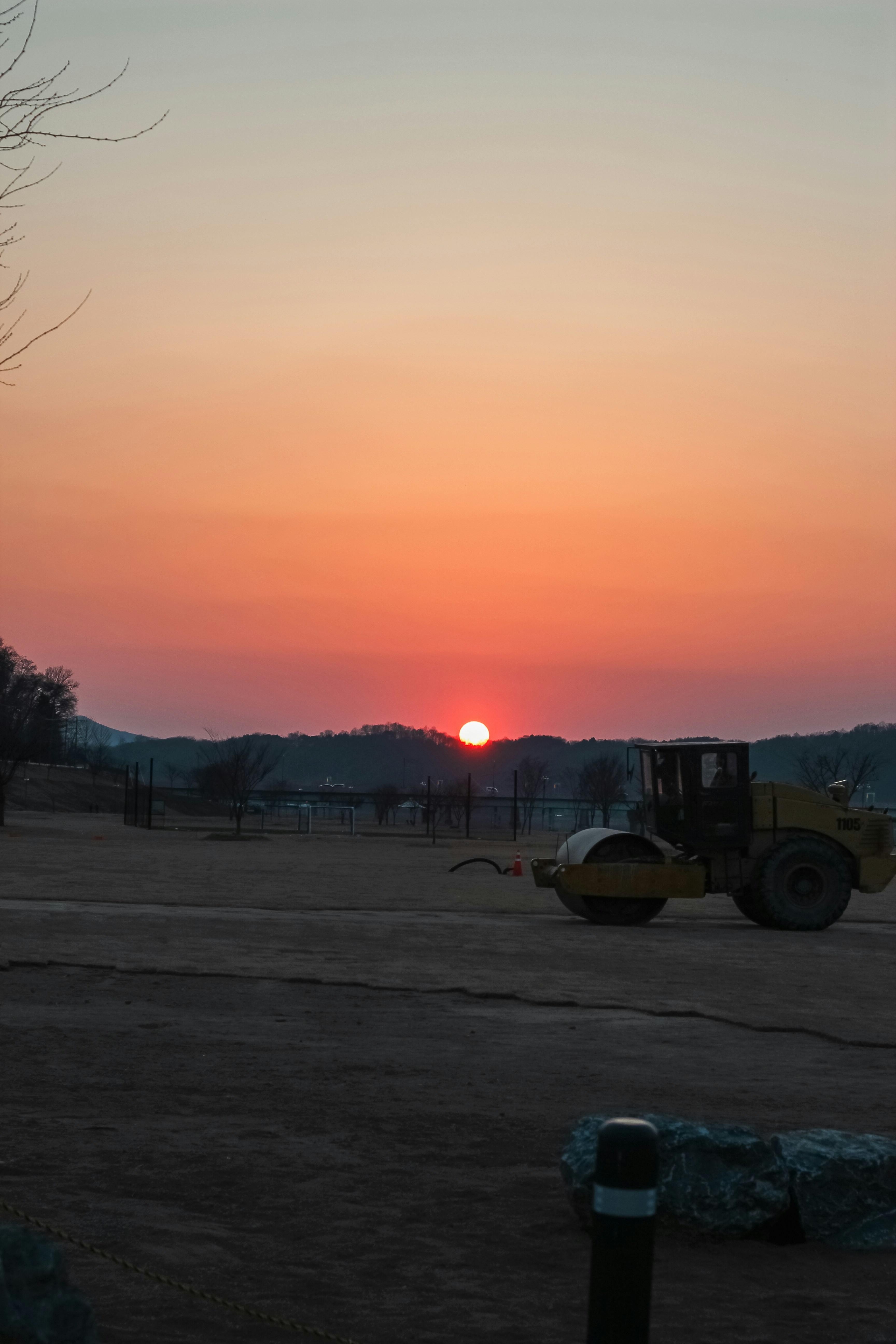 Sunset Over a Construction Site: The Fireball Soaks the Horizon