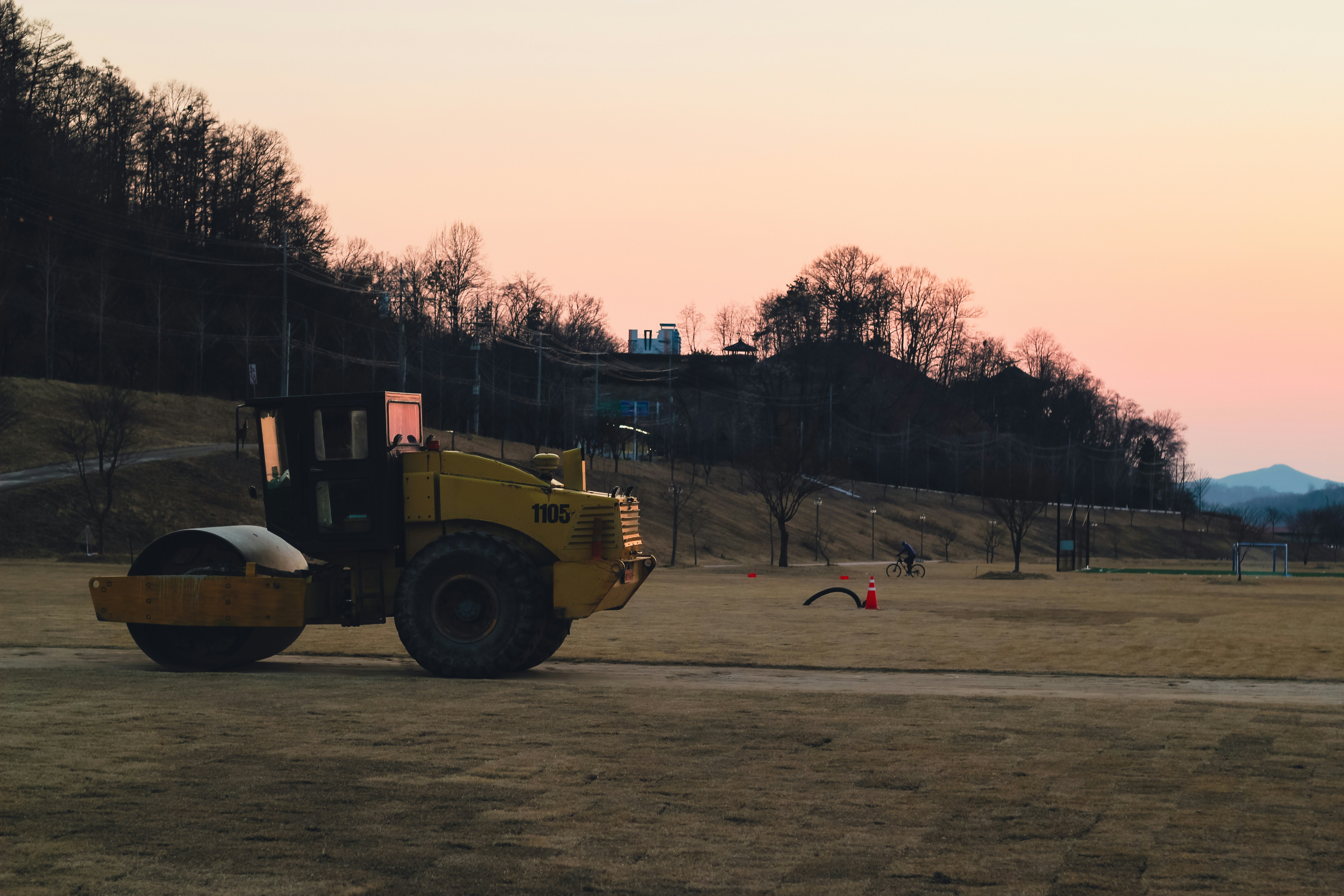 Dawn Light Over a Looming Loader on a Quiet Field
