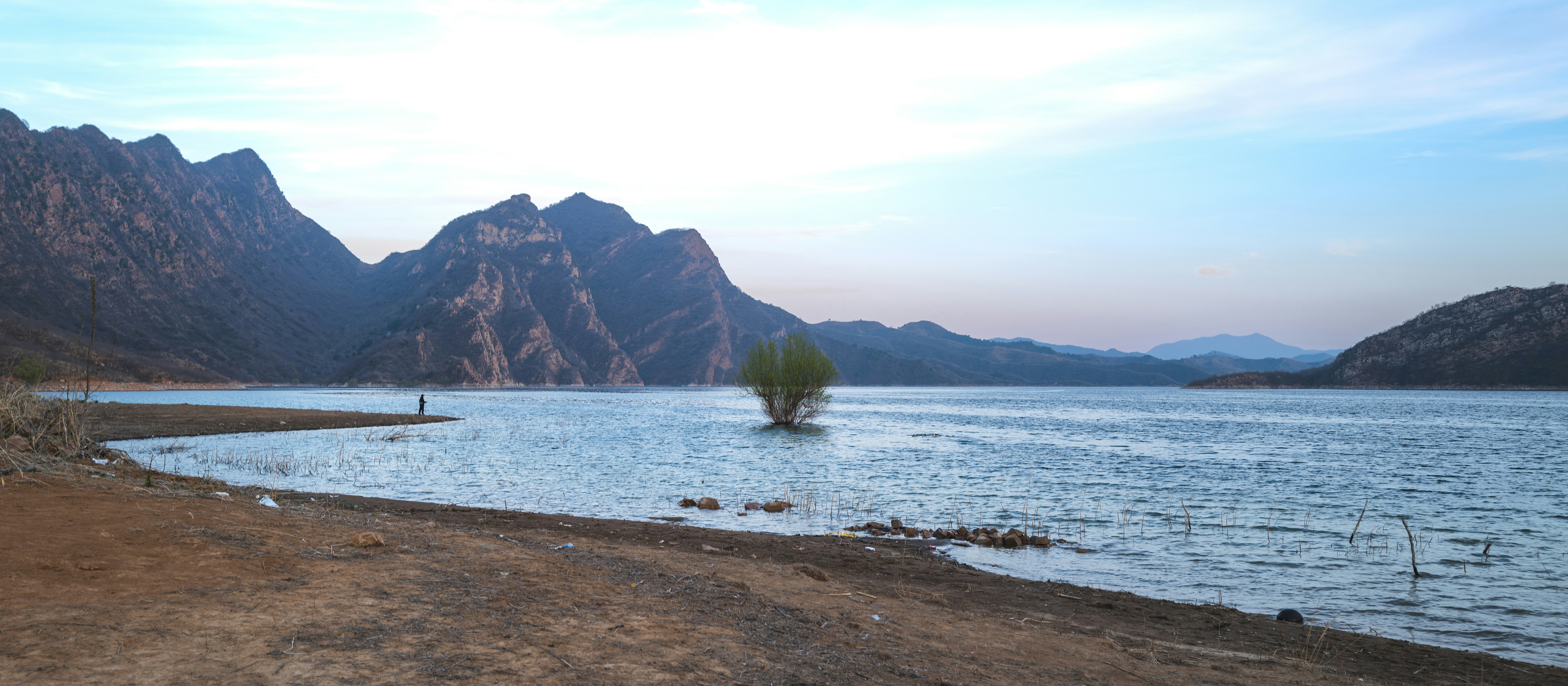 Serene Lakeside Between Distant Peaks