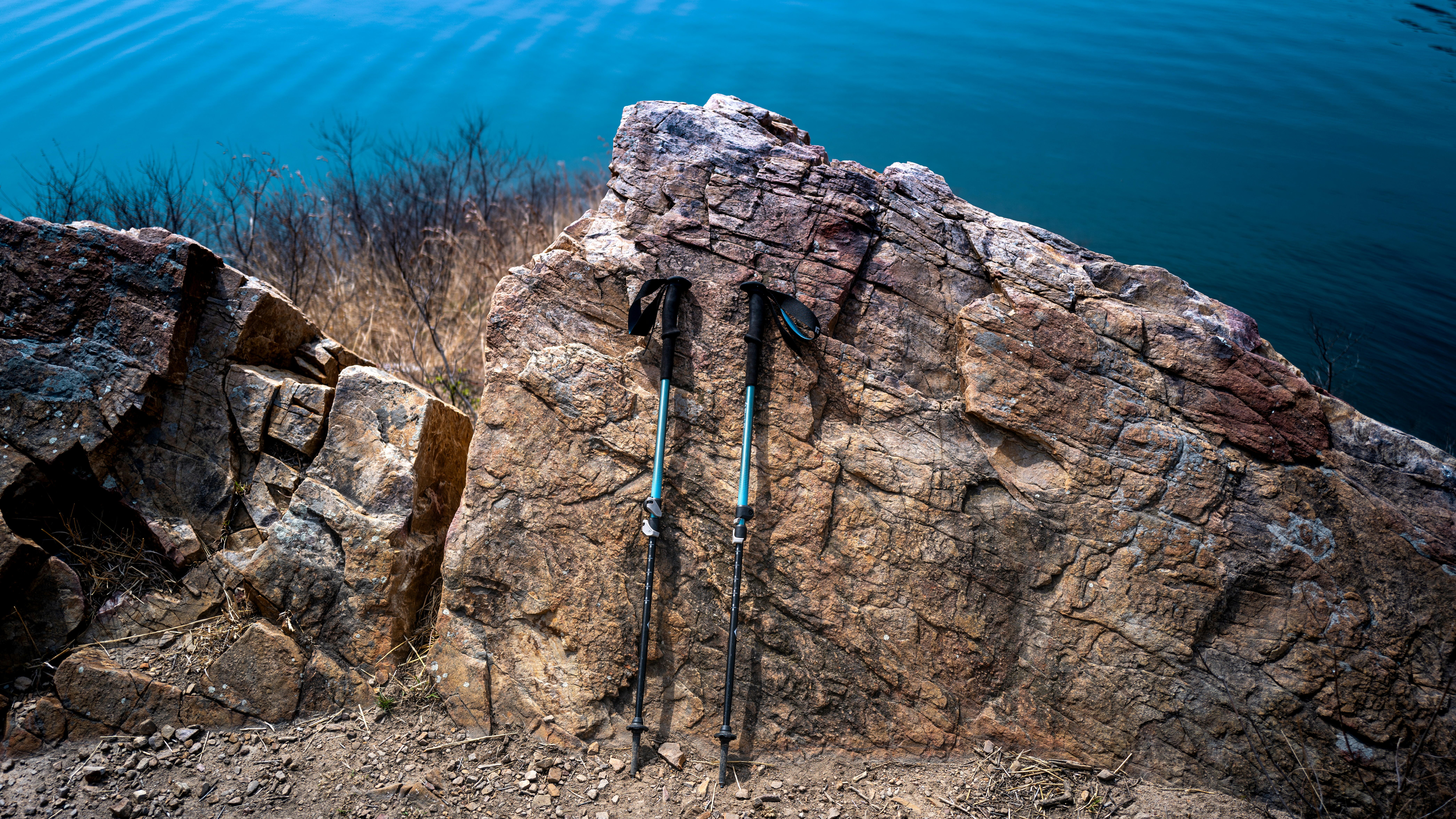 Rugged Outcrop with Alpine Gear Anchoring the Edge
