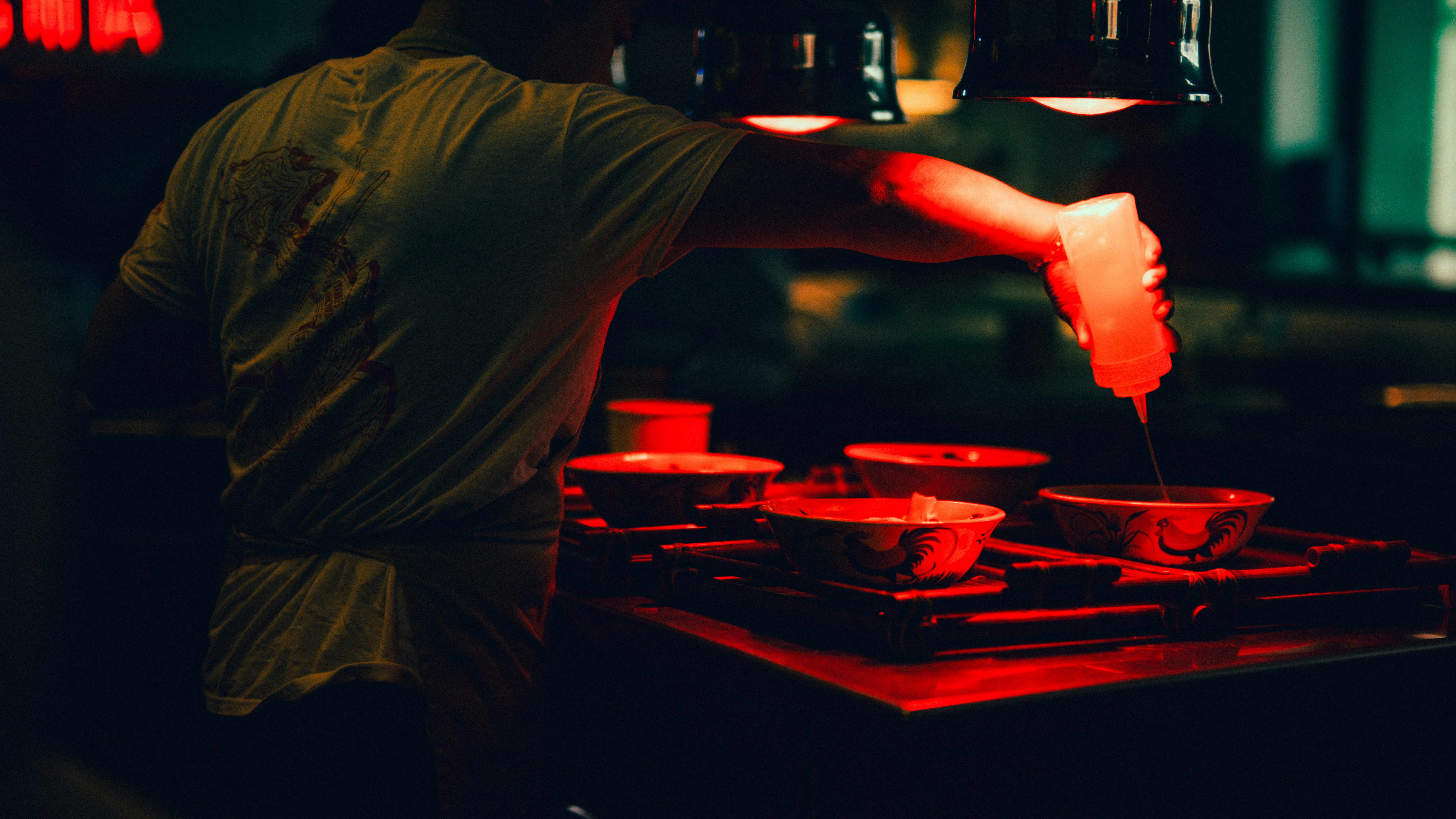 Crimson Pour: Night Kitchen Hands in a Glowing Cuisine Studio