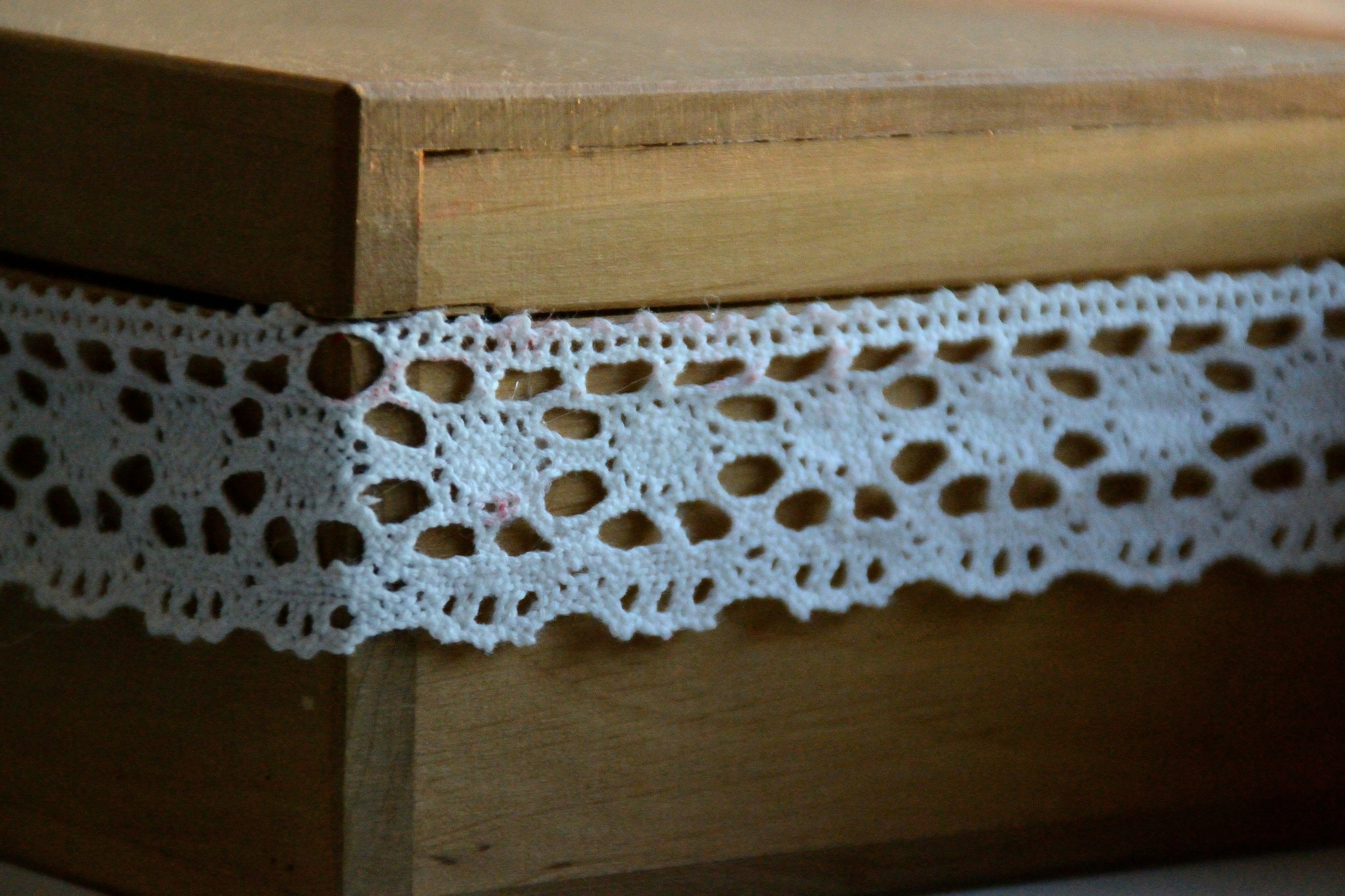 Lace Across Walnut: Quiet Detail on a Wooden Drawer