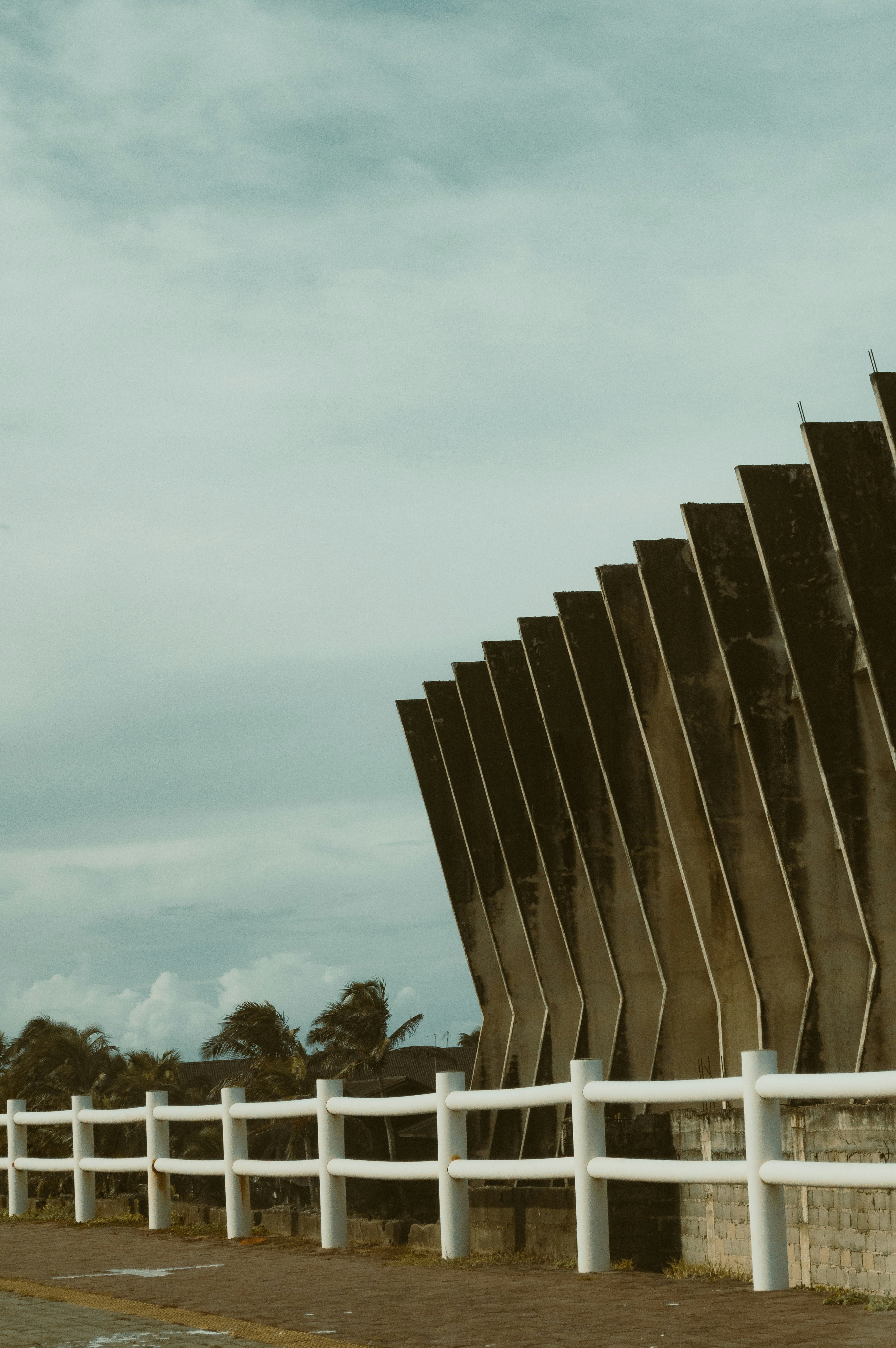 Arched Angles: Coastal Pier Rails Meet Seawall Gothic Shapes