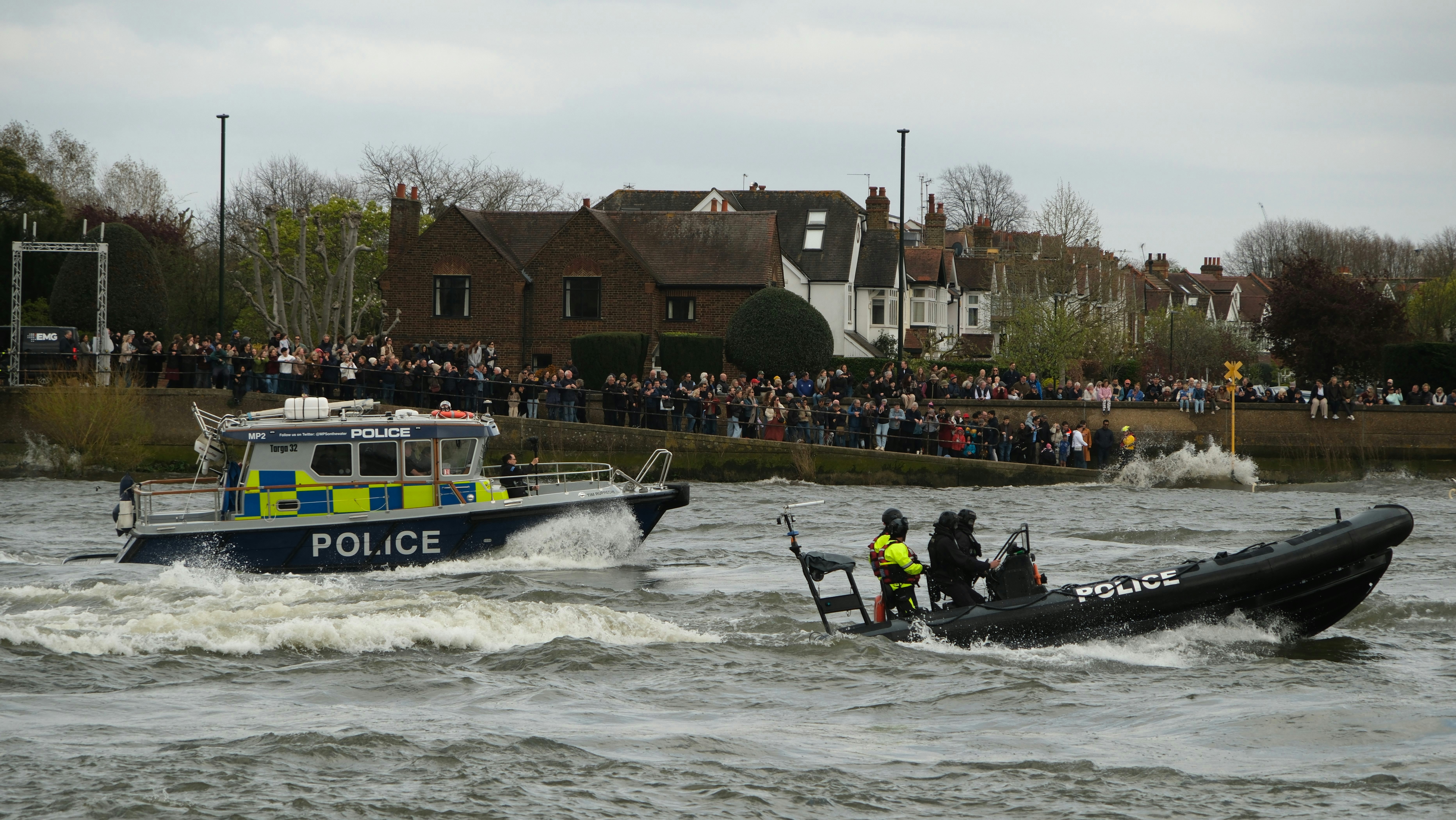 Crowd and Police Boats Rally the Riverbank