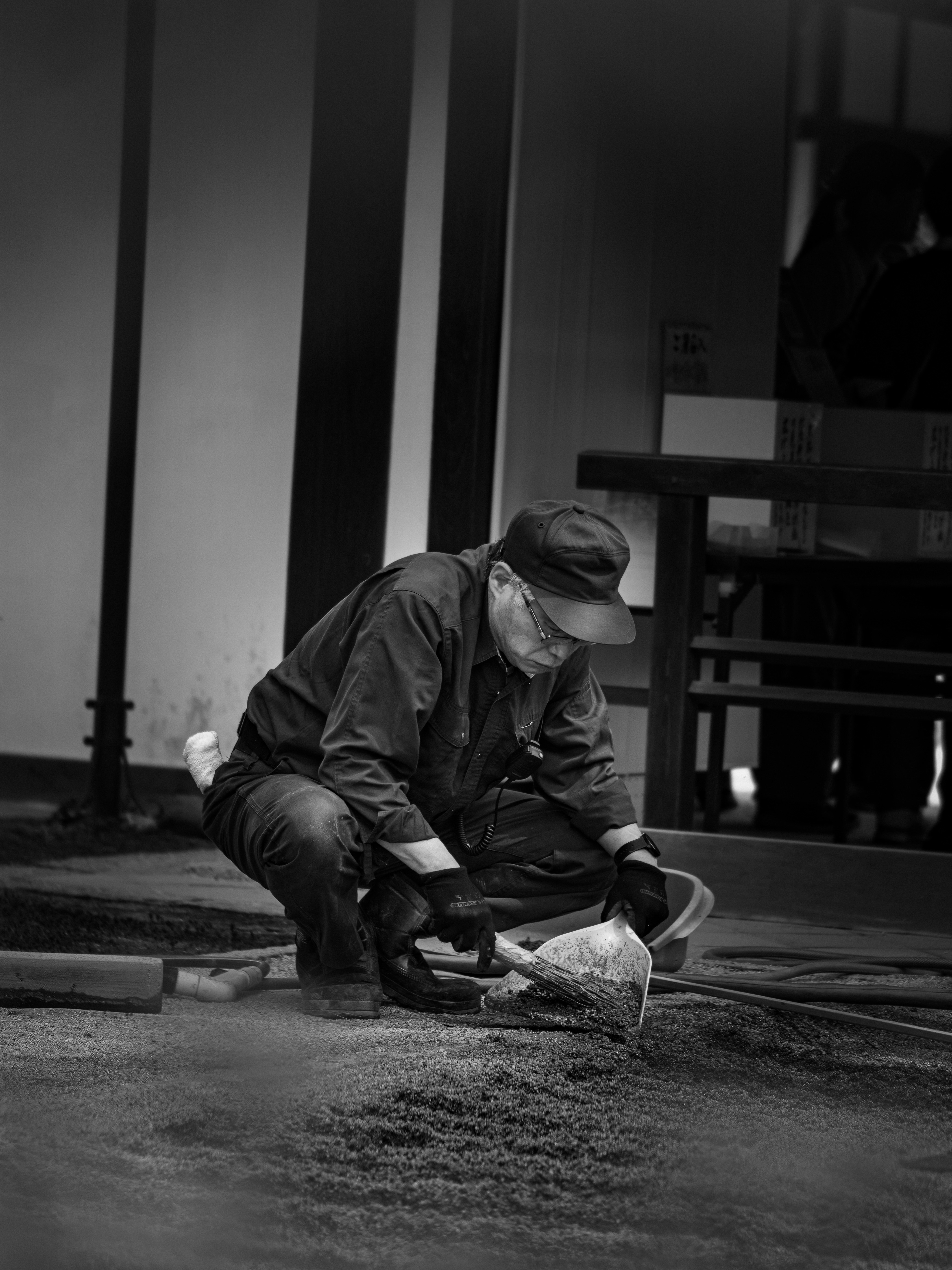 Groundwork in Focus: A Worker Shaping Gravel at Dusk