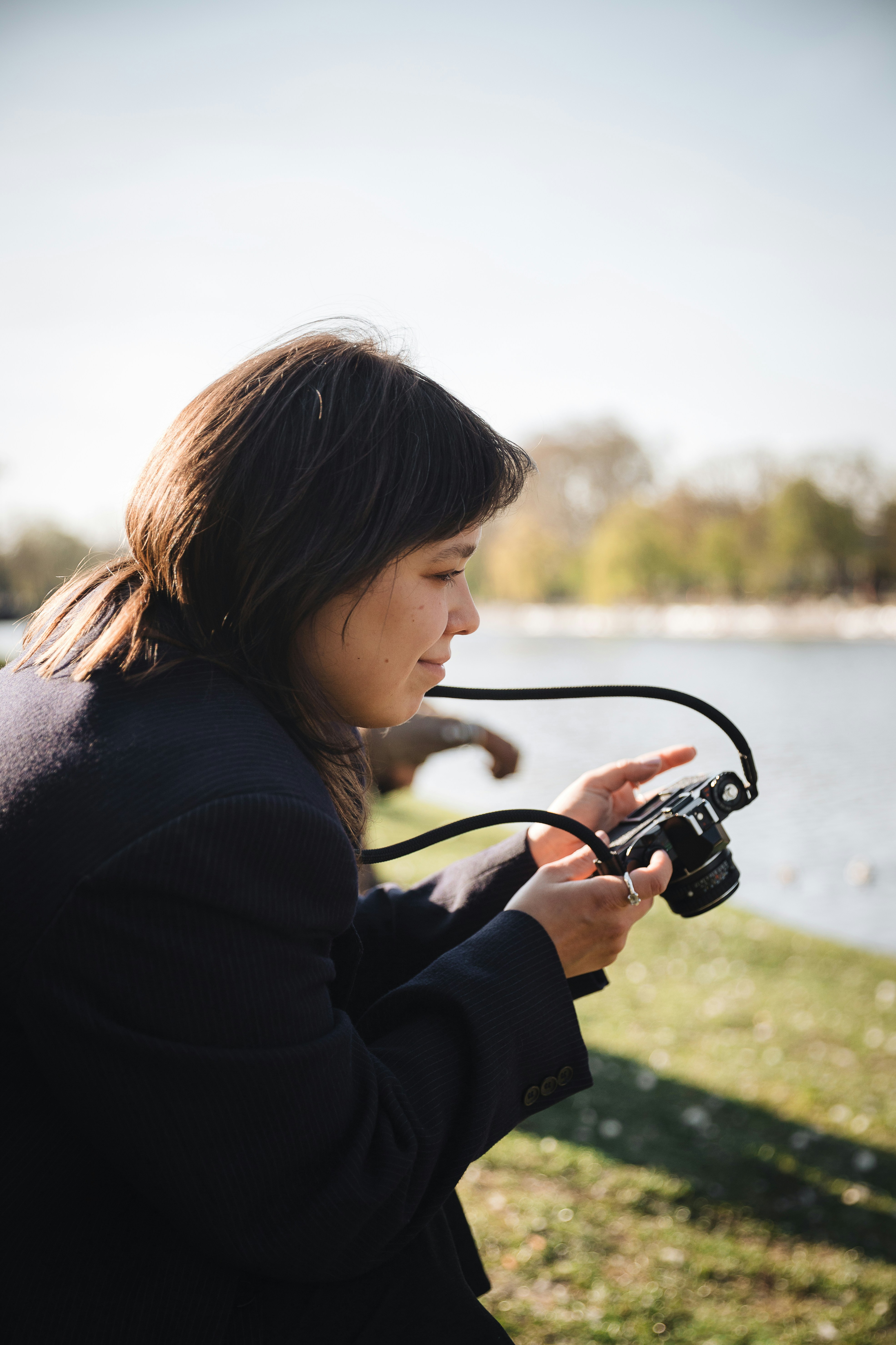 On the Shoreline, a Photographer in Quiet Focus