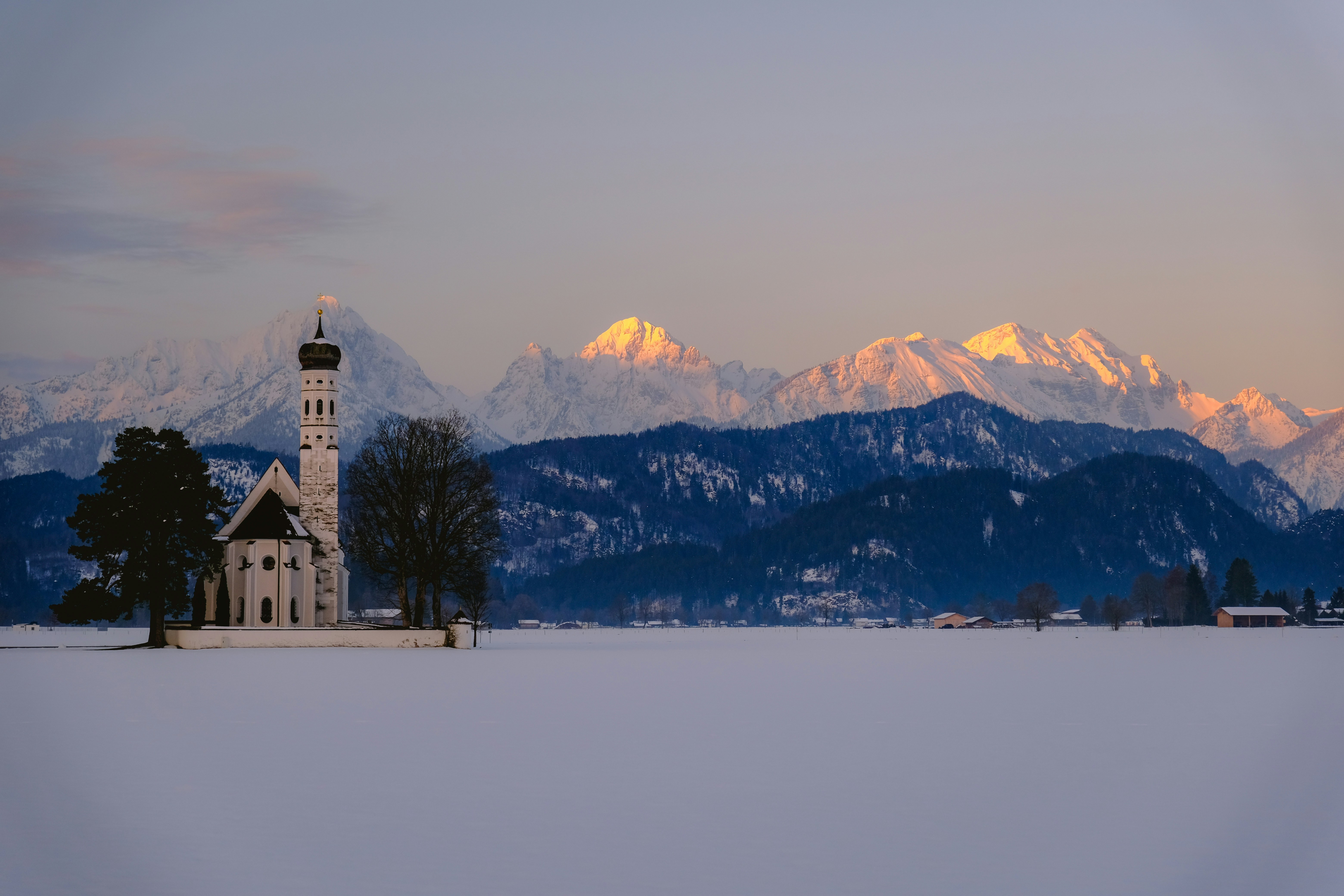 Snowbound Chapel with Alpine Grandeur at Twilight