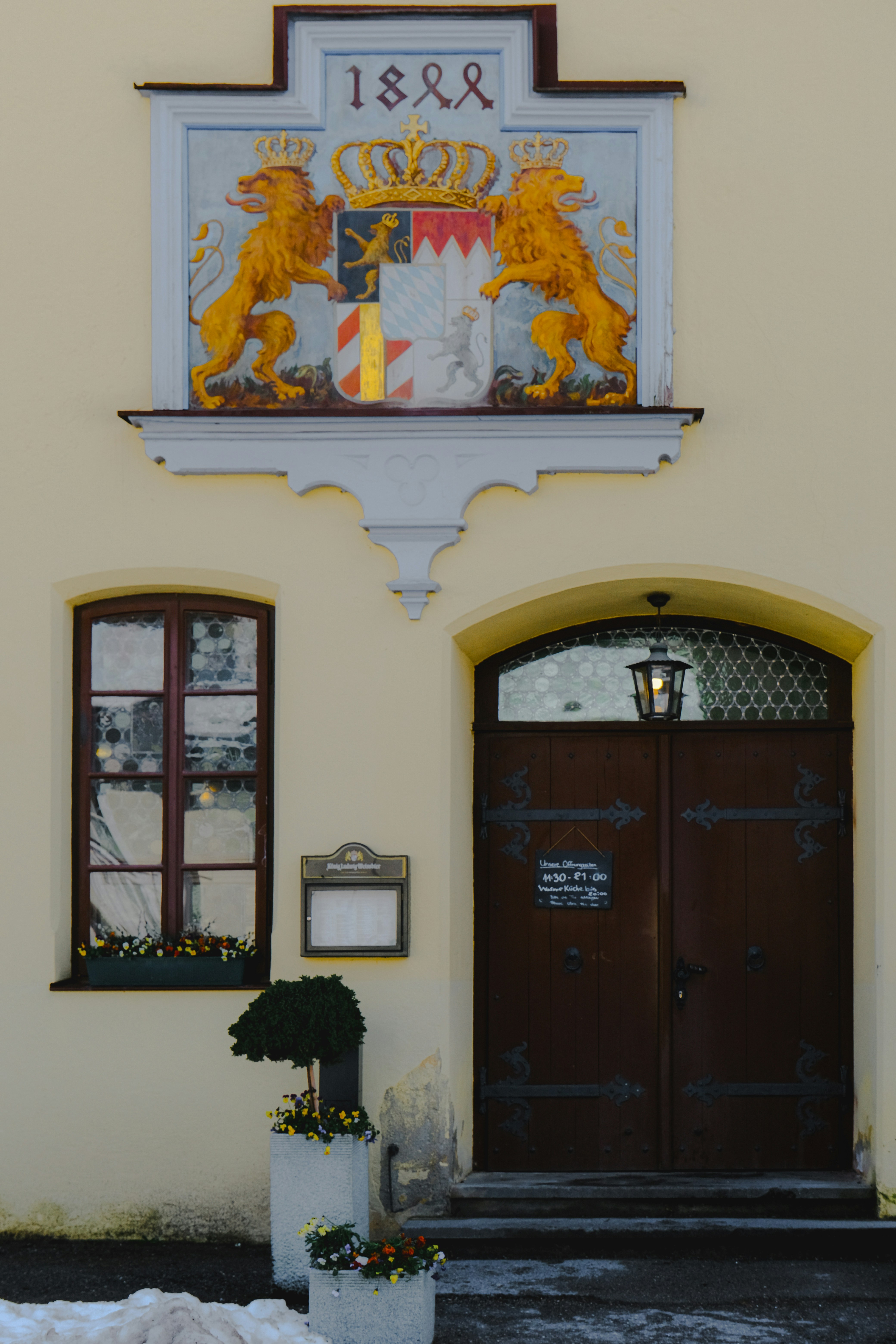 Coat of Arms Over a Sunny European Facade
