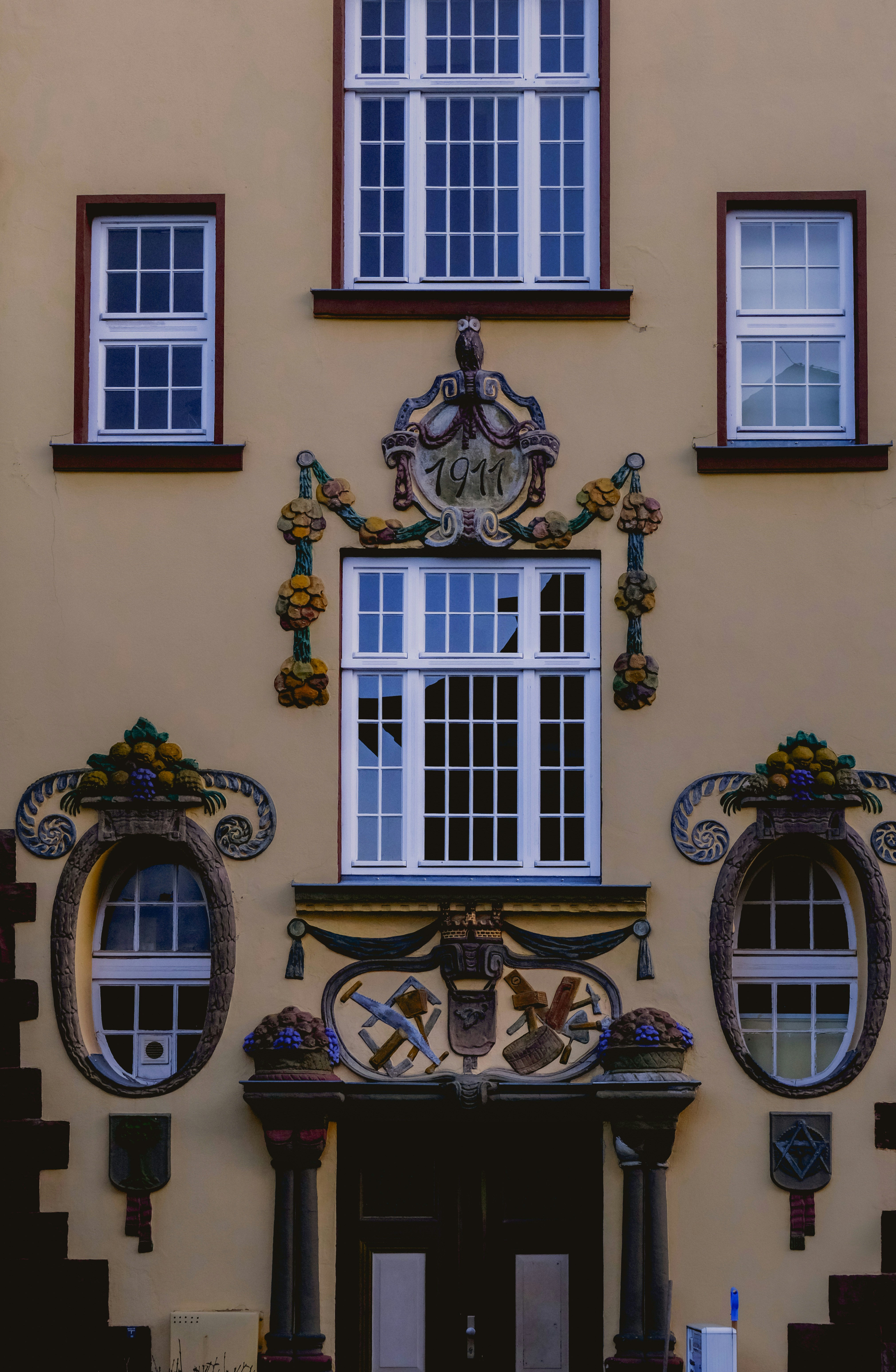 Ornate Facade of a Historic Building with Decorative Crest and Windows