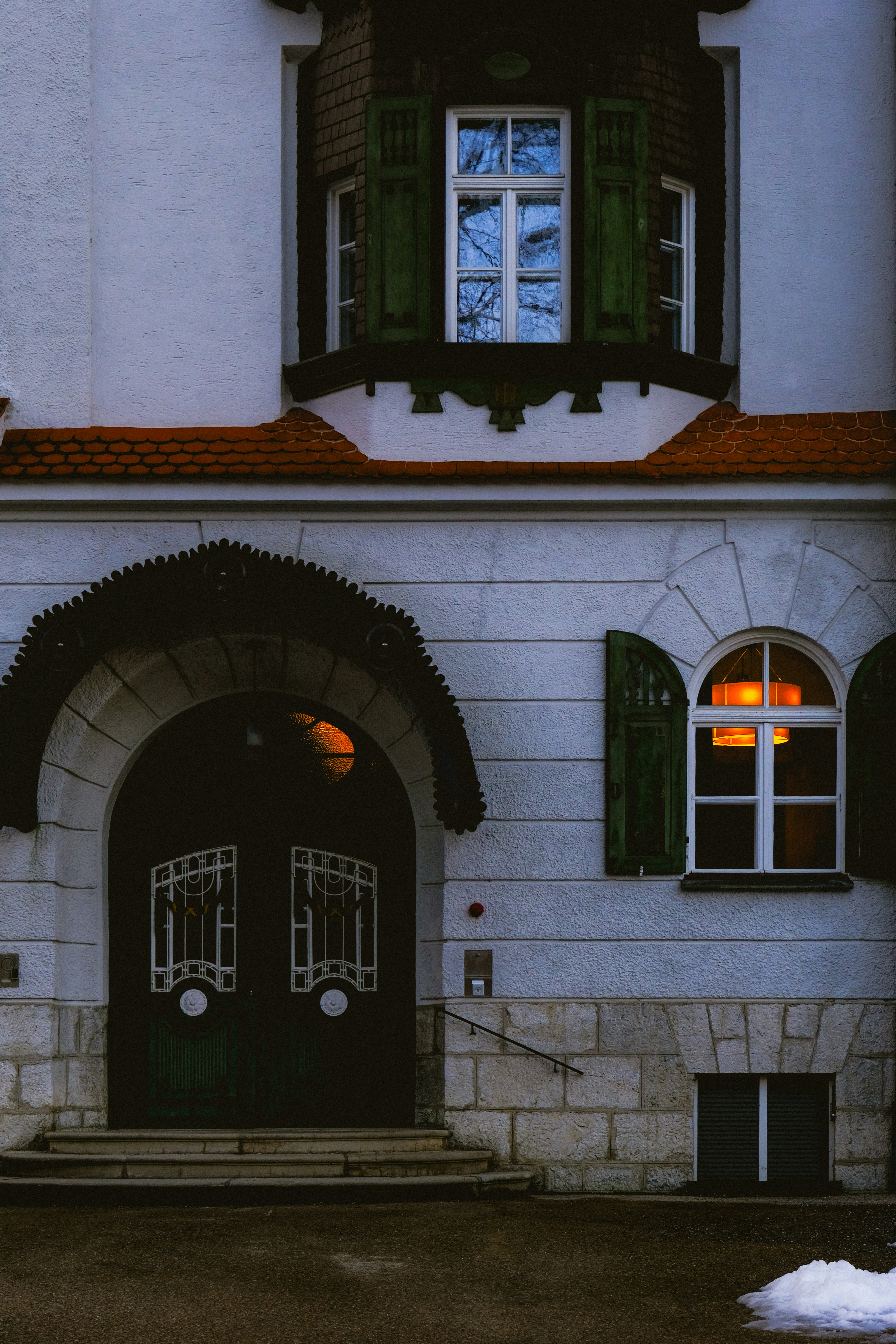 Green-arched Entryway Under Nightfall with Warm Interior Glow