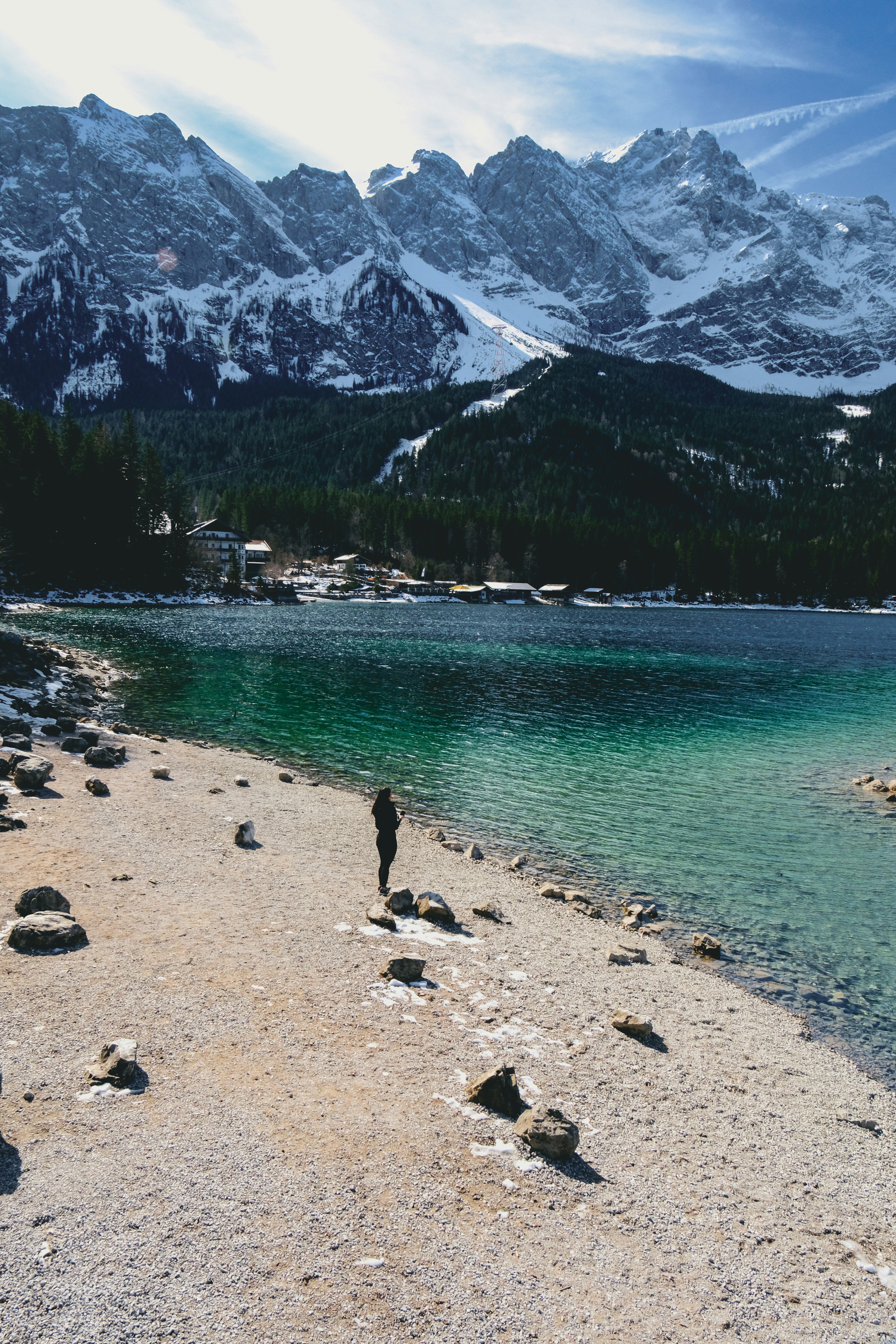 Solitary Wanderer at the Emerald Shore beneath Alpine Peaks