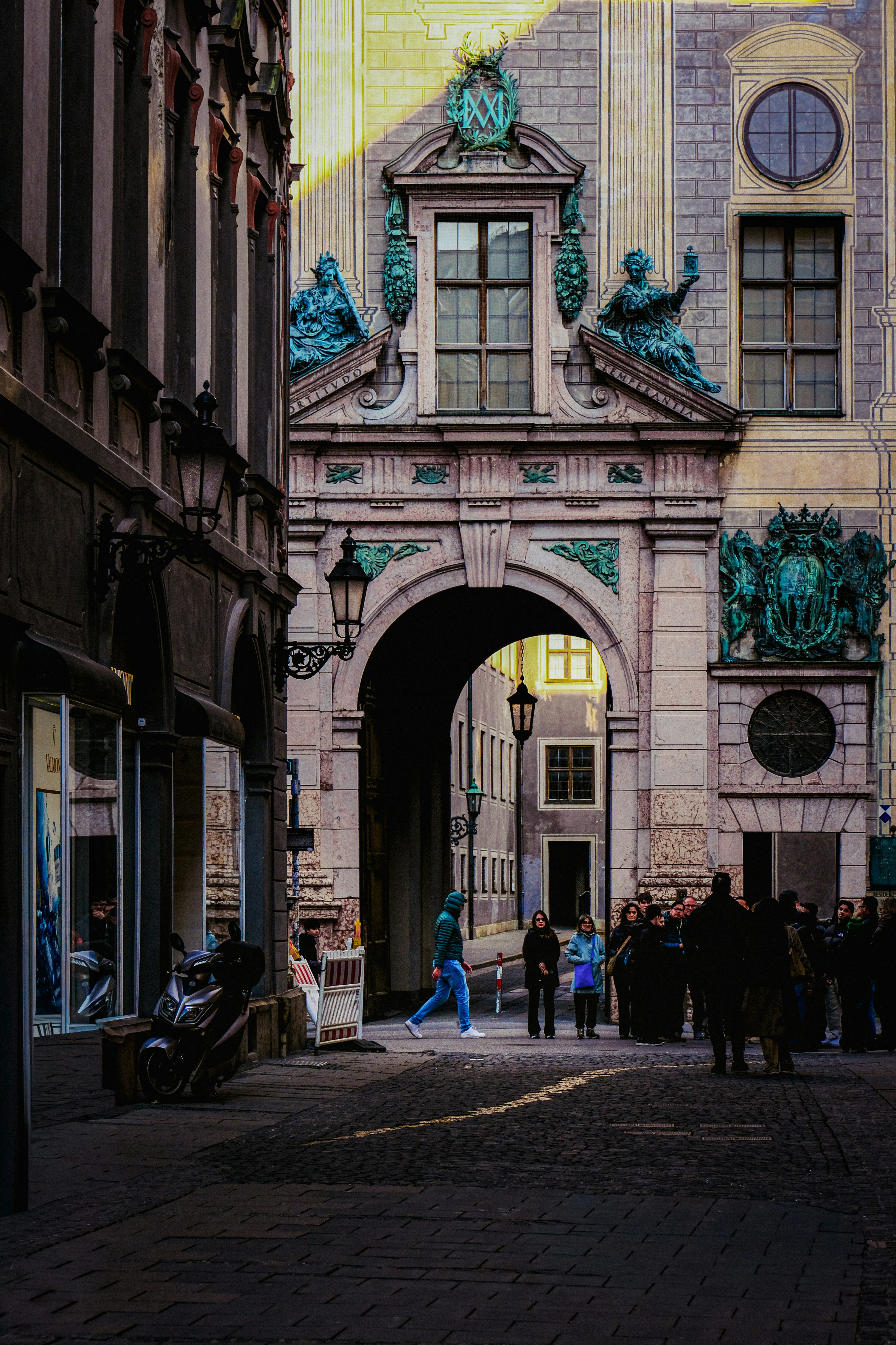 Archway Evening Pulse: People Gather Under the Historic Gate