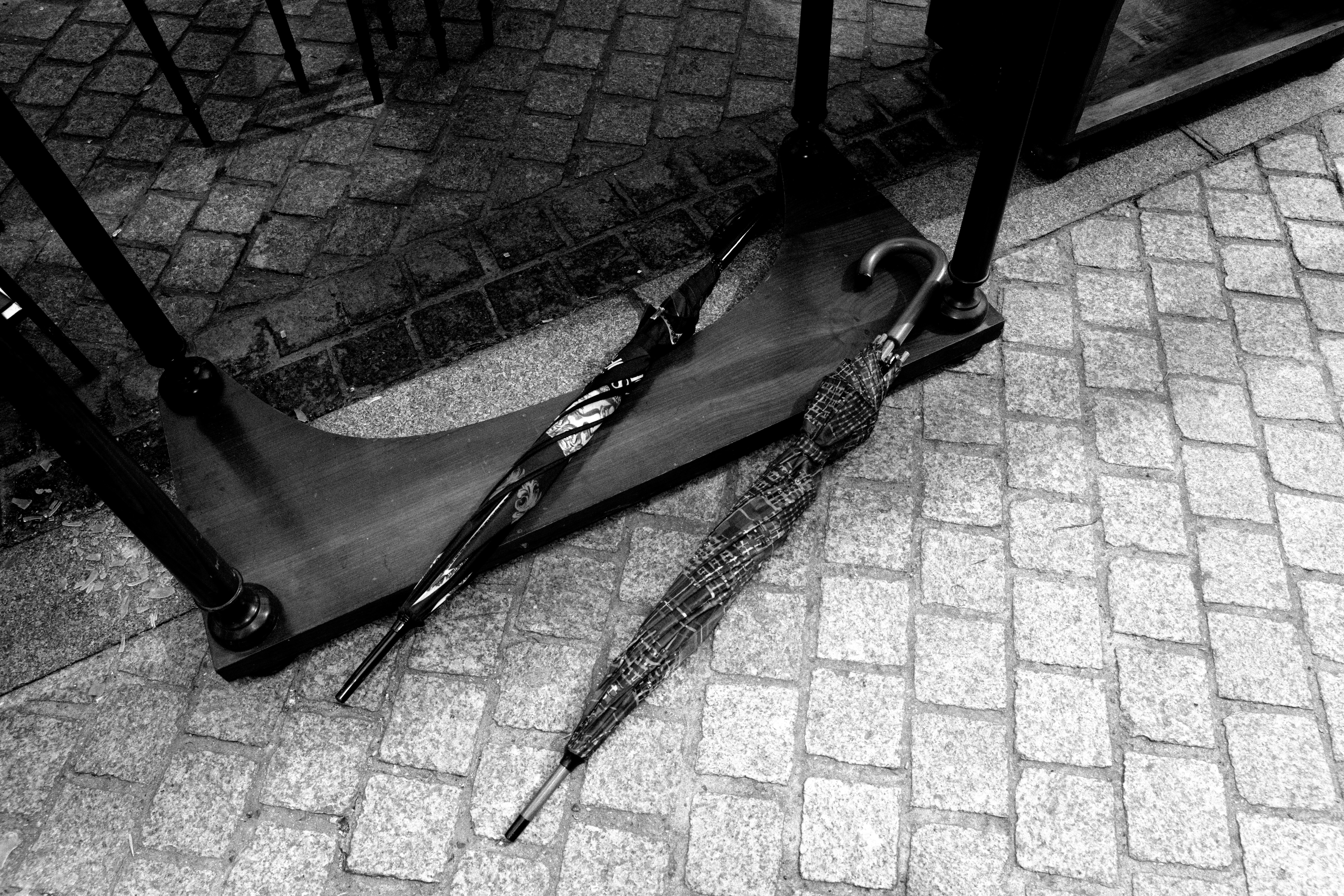 Umbrellas Resting on a Curved Cobblestone Threshold