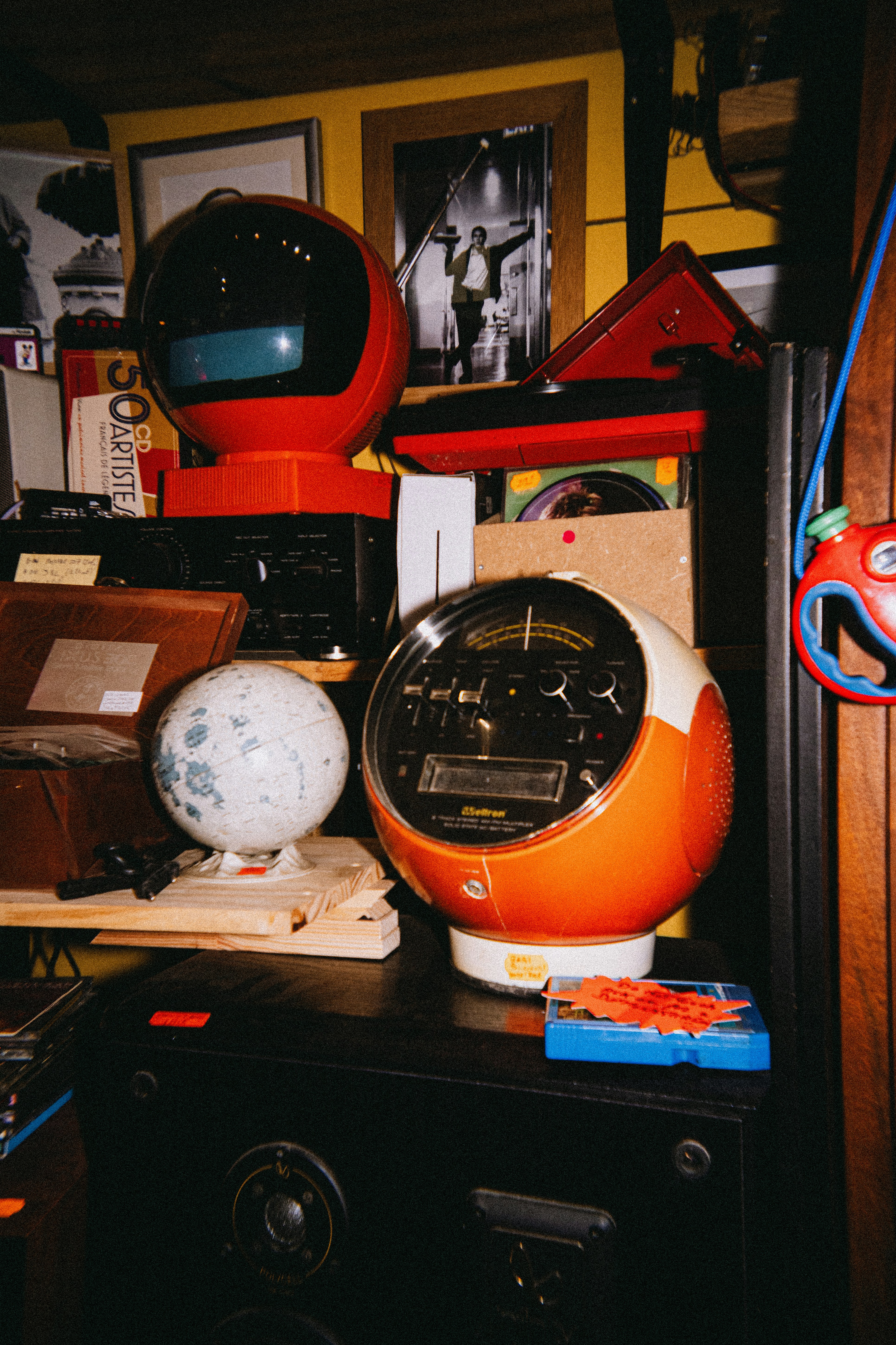 Orange Spheres and Retro Gear: A Curated Office Shelf in Rich Color