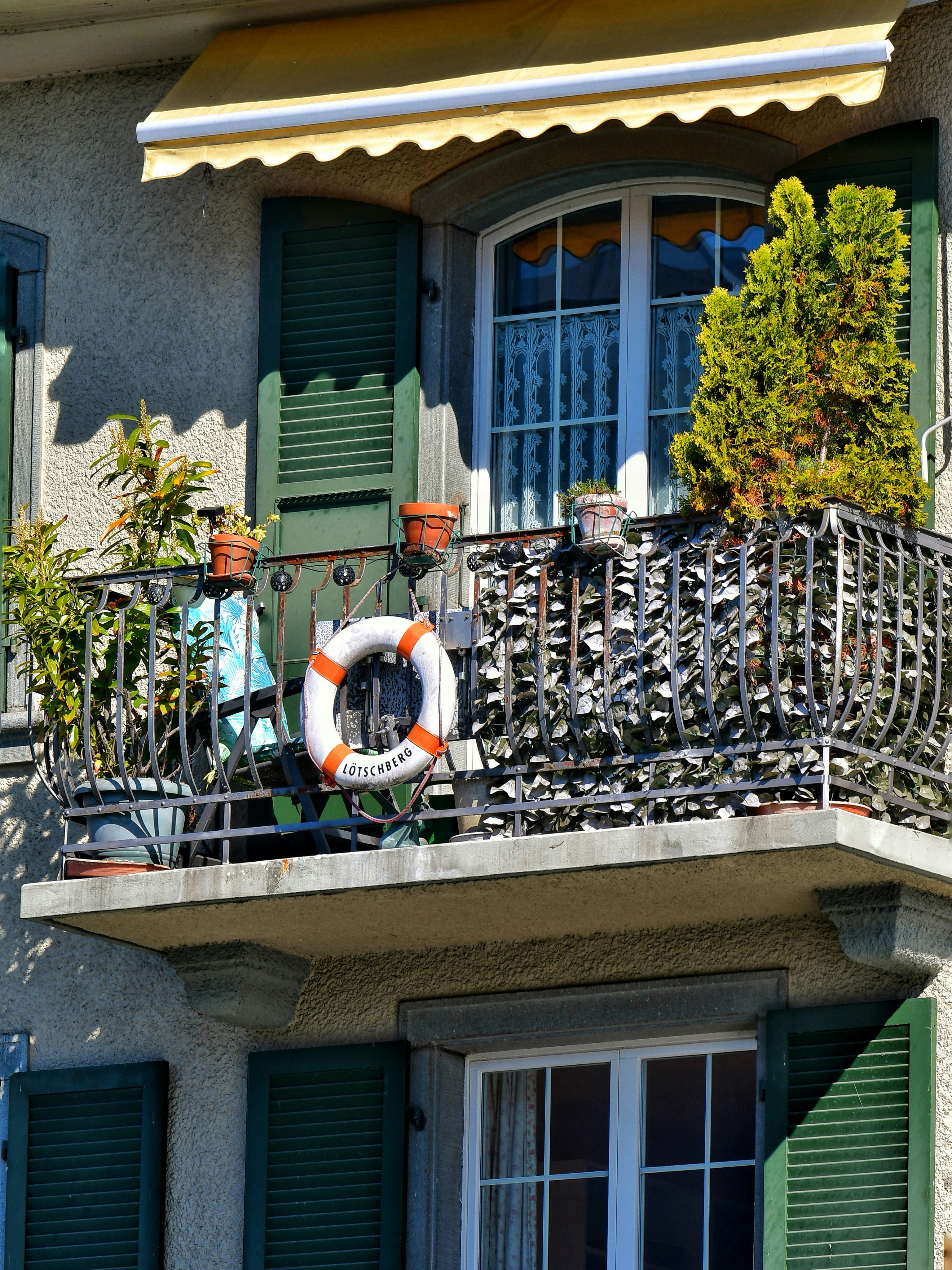 Balcony of Echoed Green: A Sunlit European Living Scene