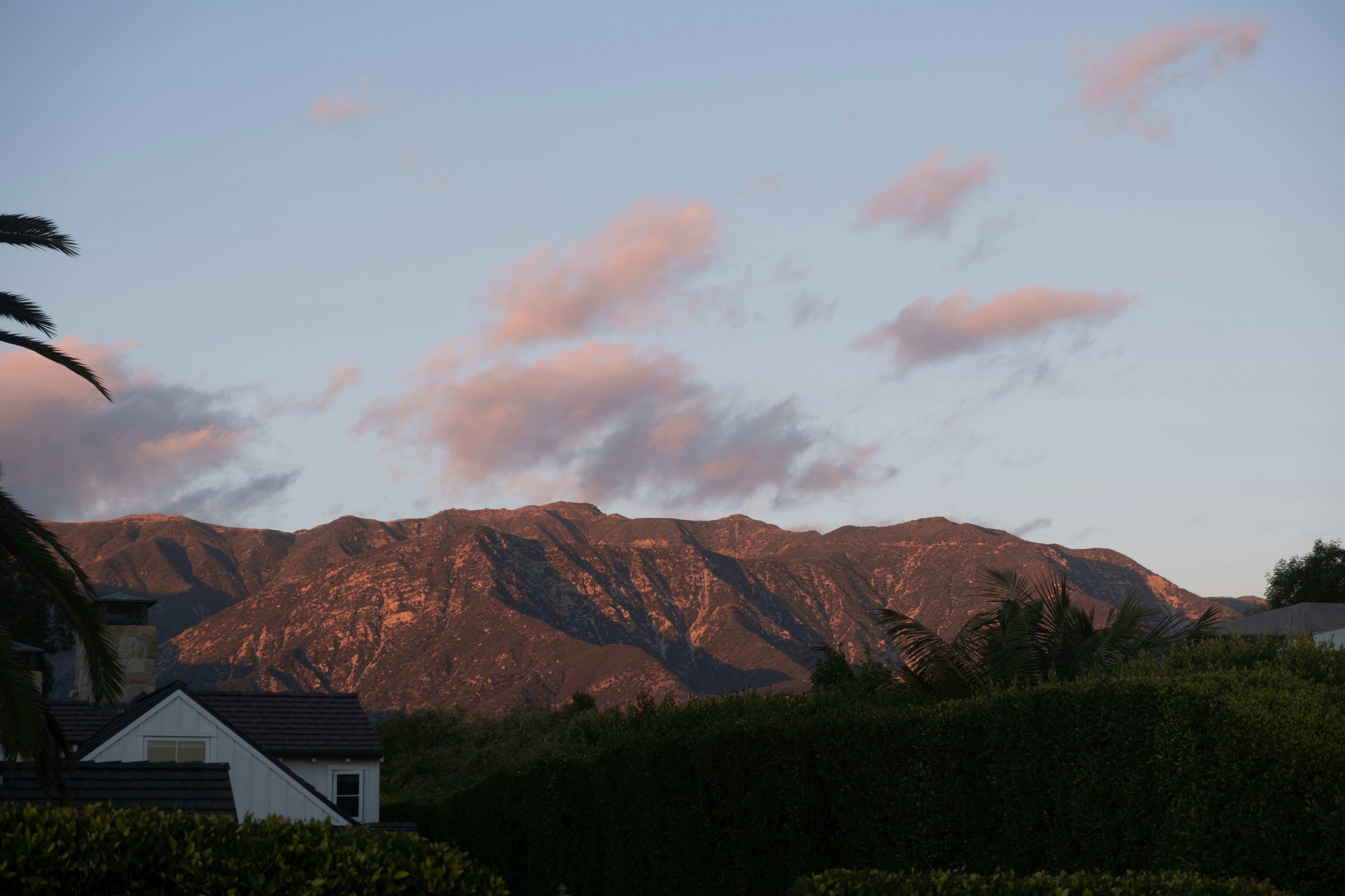 Sunlit Ridge: Distant Peaks Against a Quiet Suburban Foreground