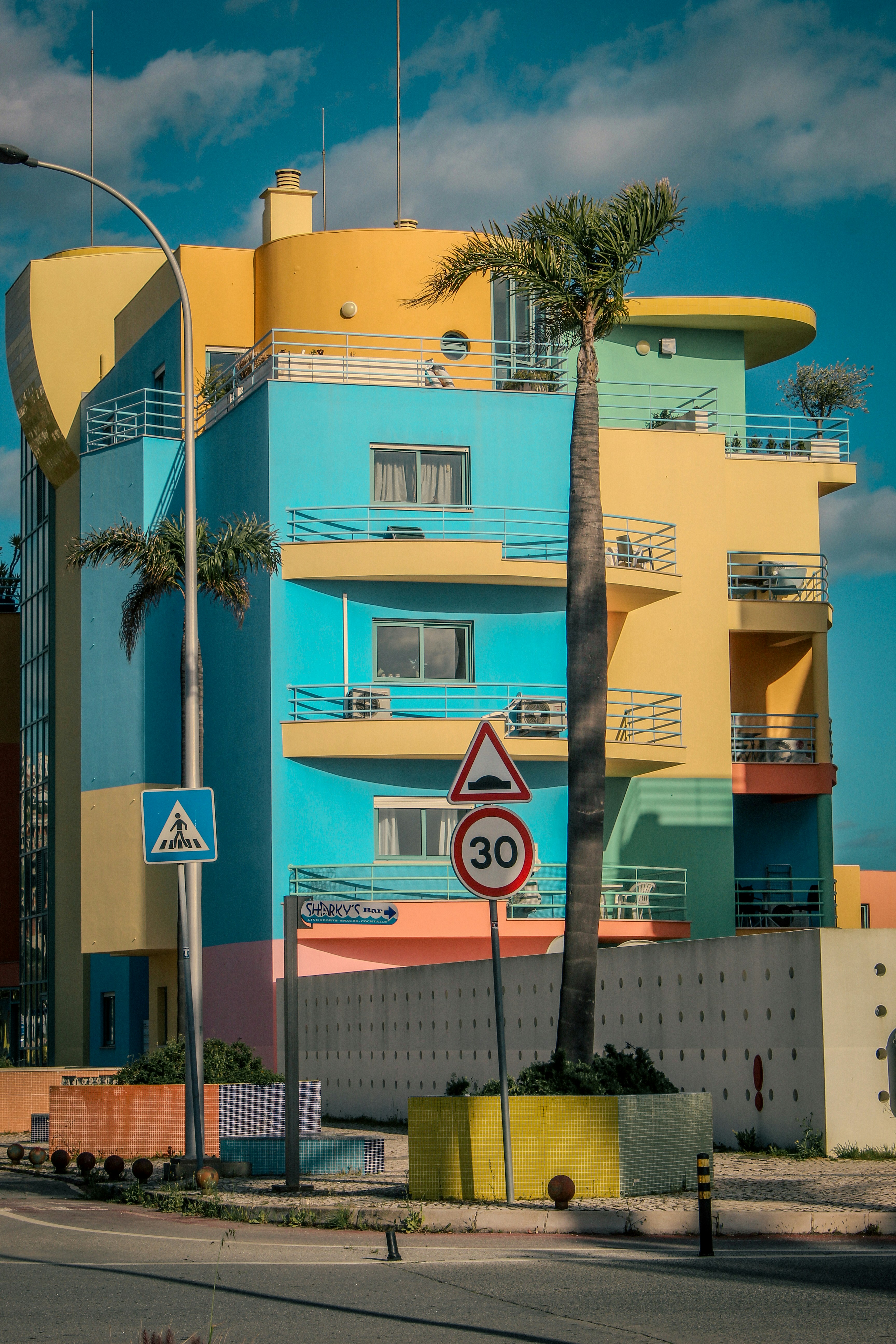 Palette of Waves: A Colorful Coastal Block Towers Over a Quiet Street