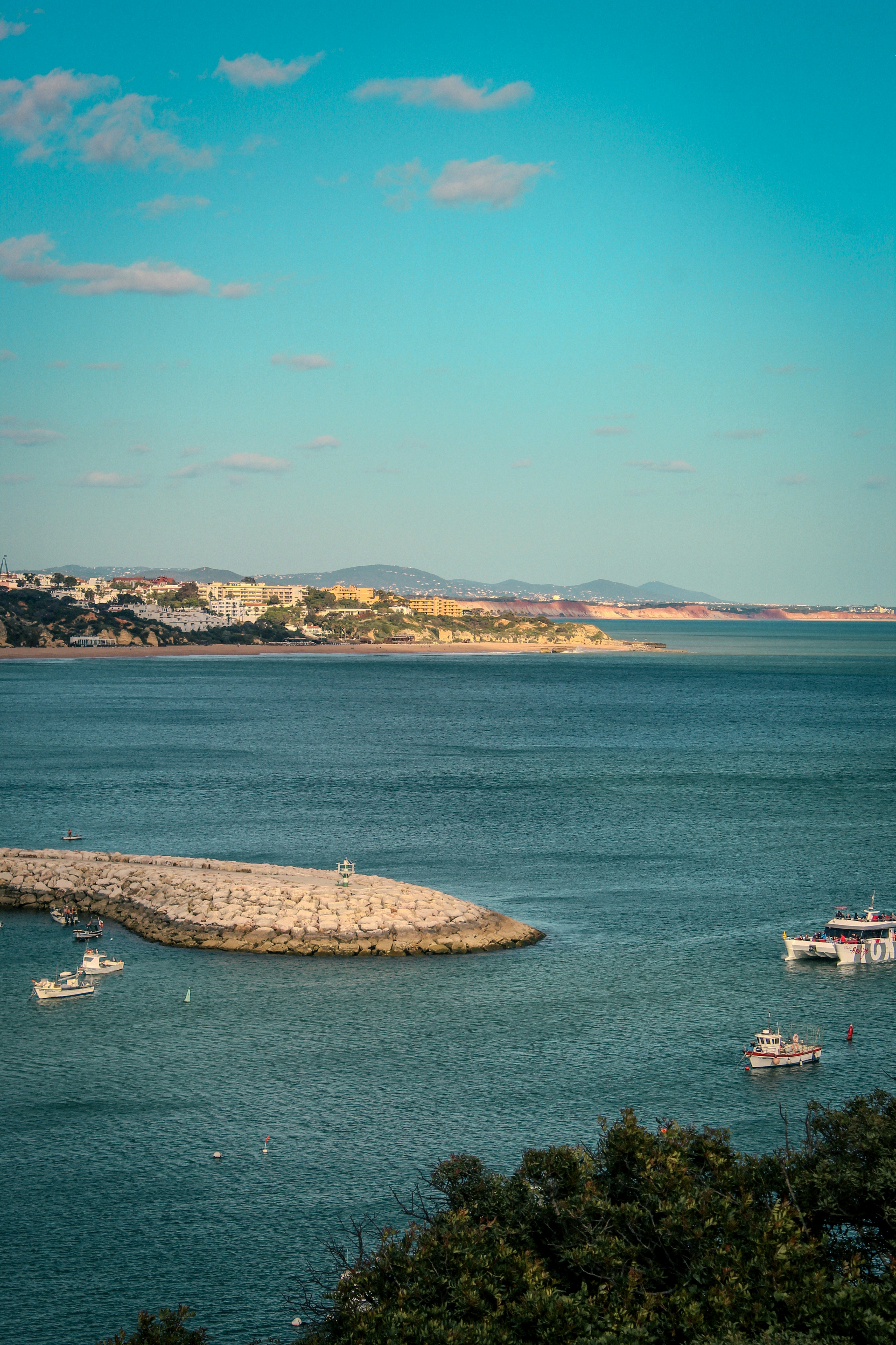 Coastal Horizon: Boats at Dusk Beneath a Clear Sky
