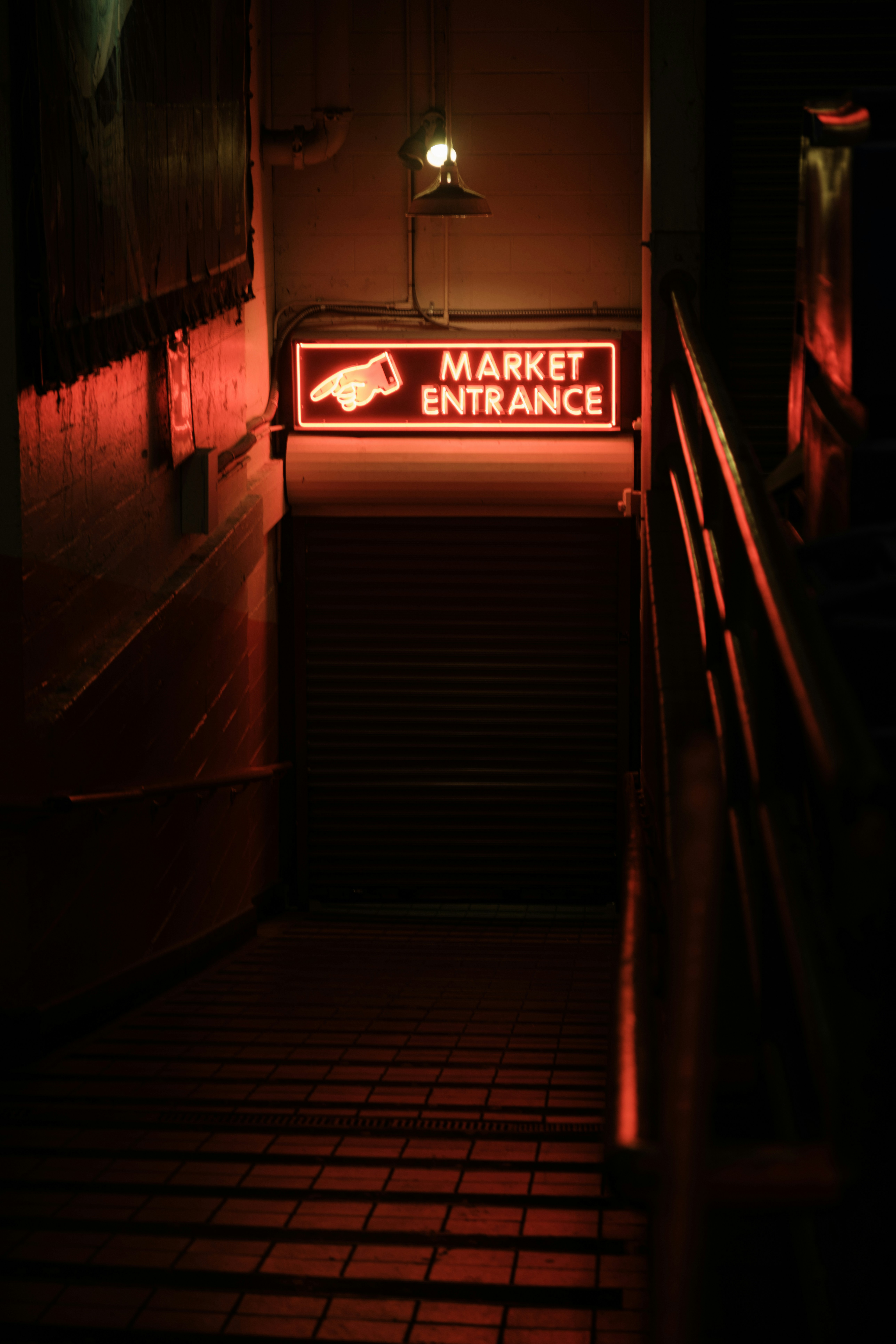 Neon Gate: Market Entrance Beneath the Staircase