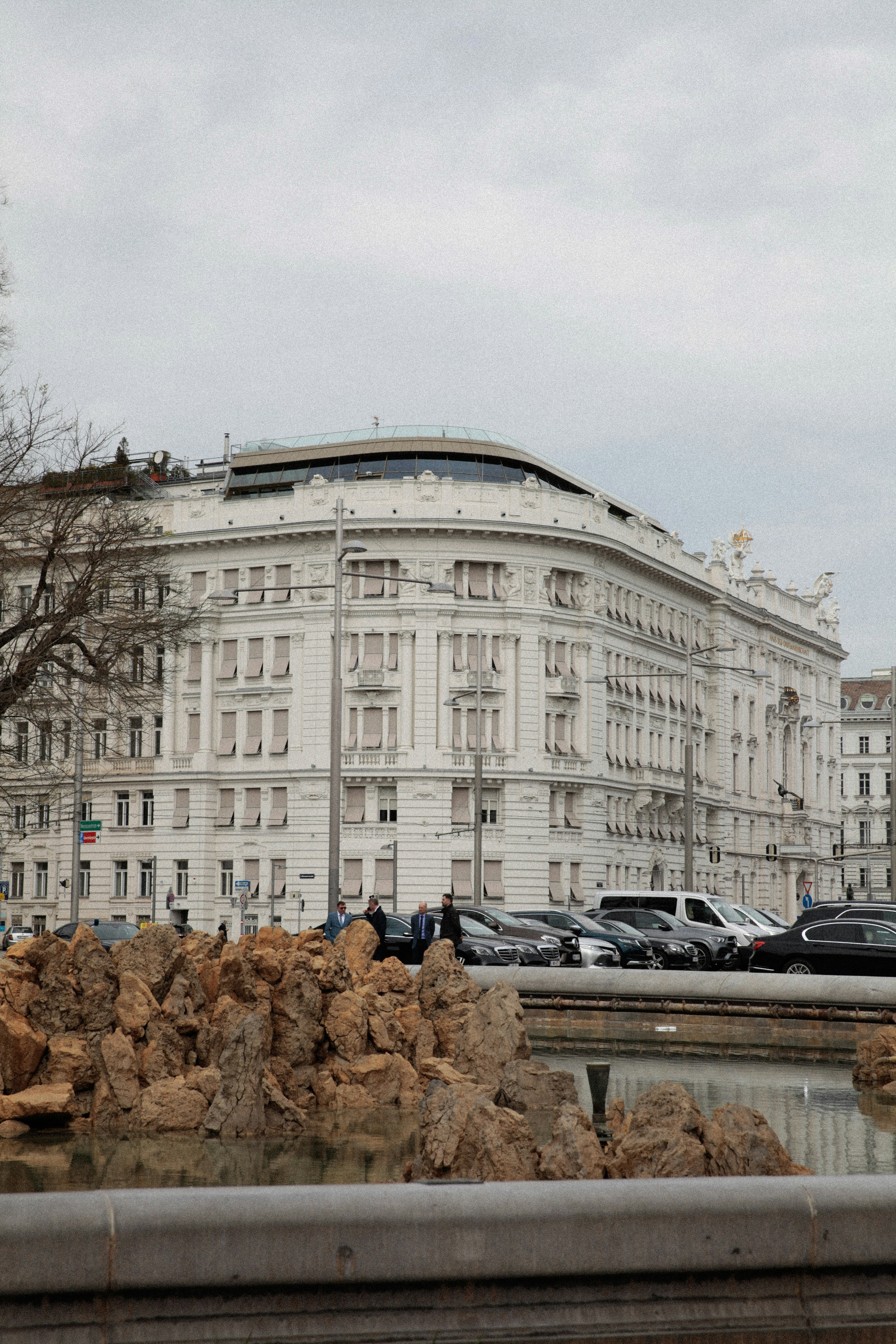 Beige Cornerstone: White Historic Building Overlooking a Stone Lake