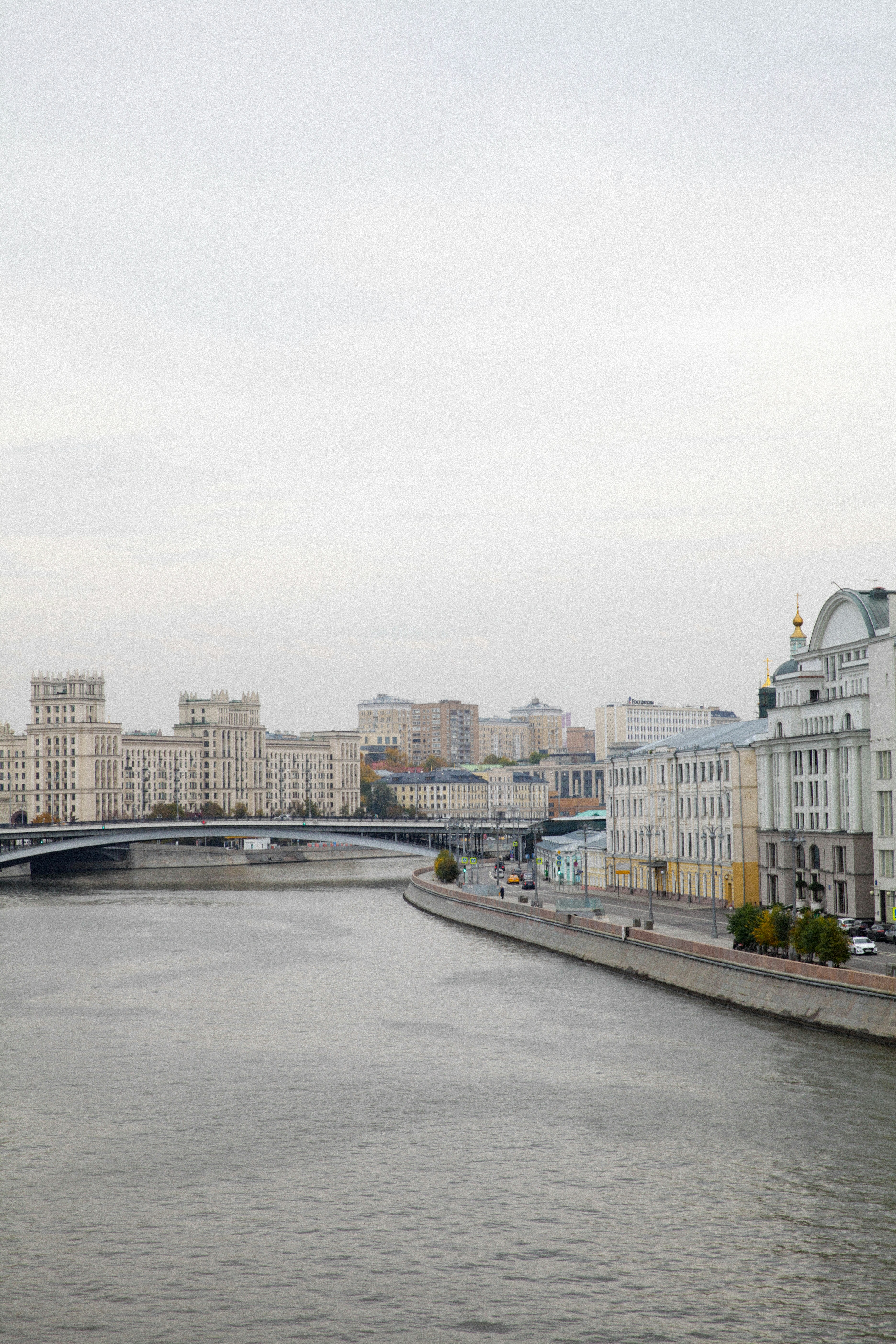 Riverfront Cityscape: A Calm Confluence of Bridges and Neoclassical Edifices