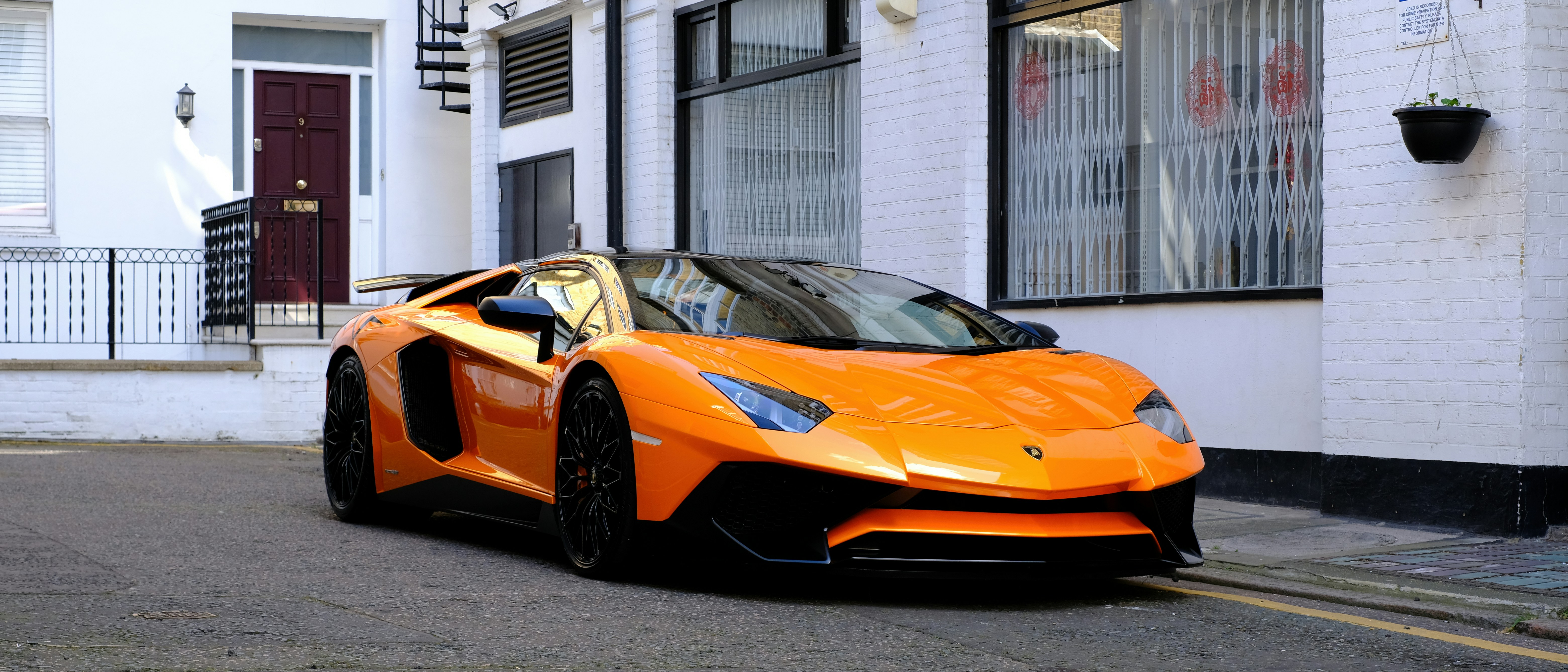 Orange Exotica: A Huracan Resting on a Quiet City Street