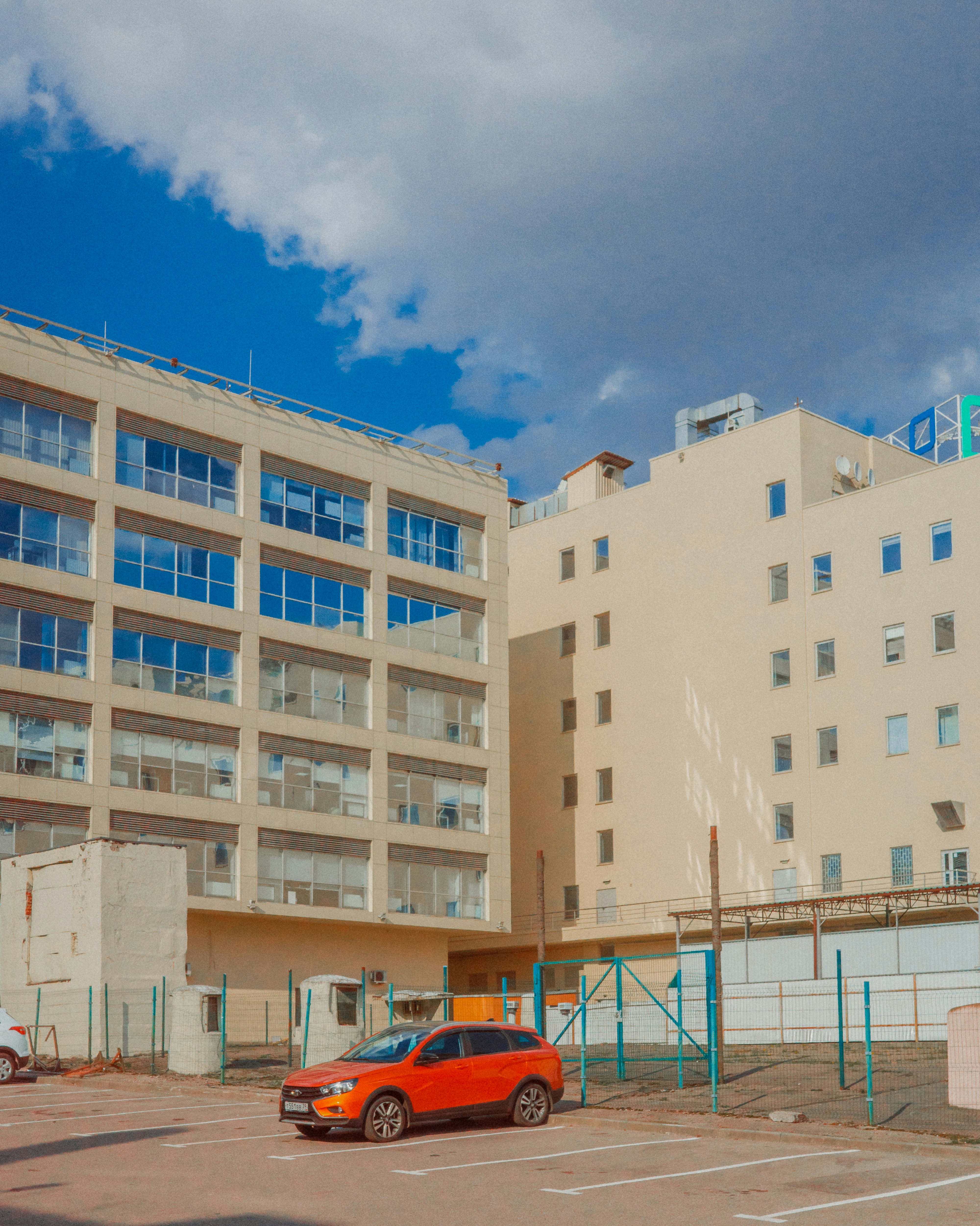 Urban Red Runway: A Bold Car Against the Modern Facade