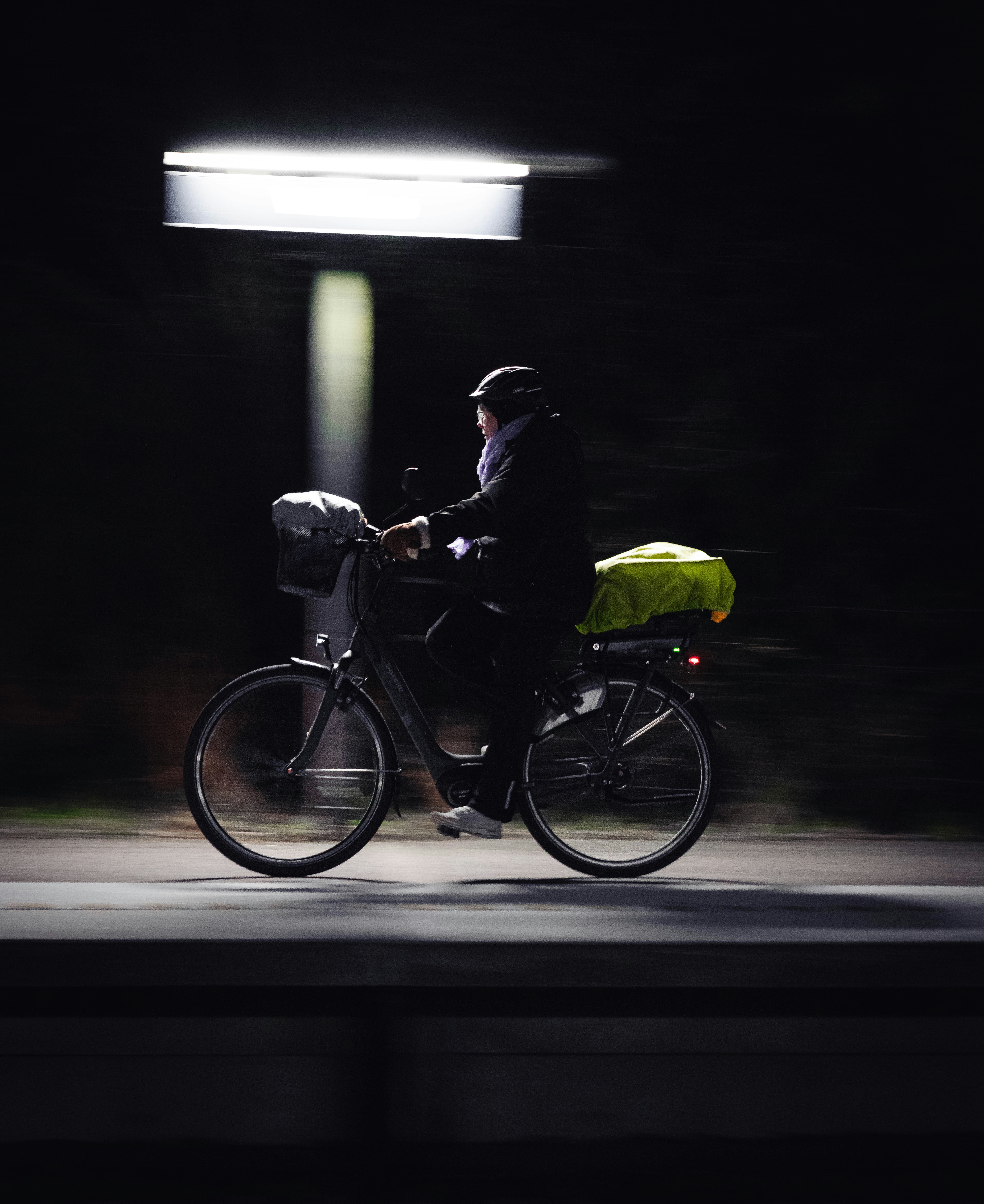 Night Ride: A cyclist glides through a blurred, moonlit street