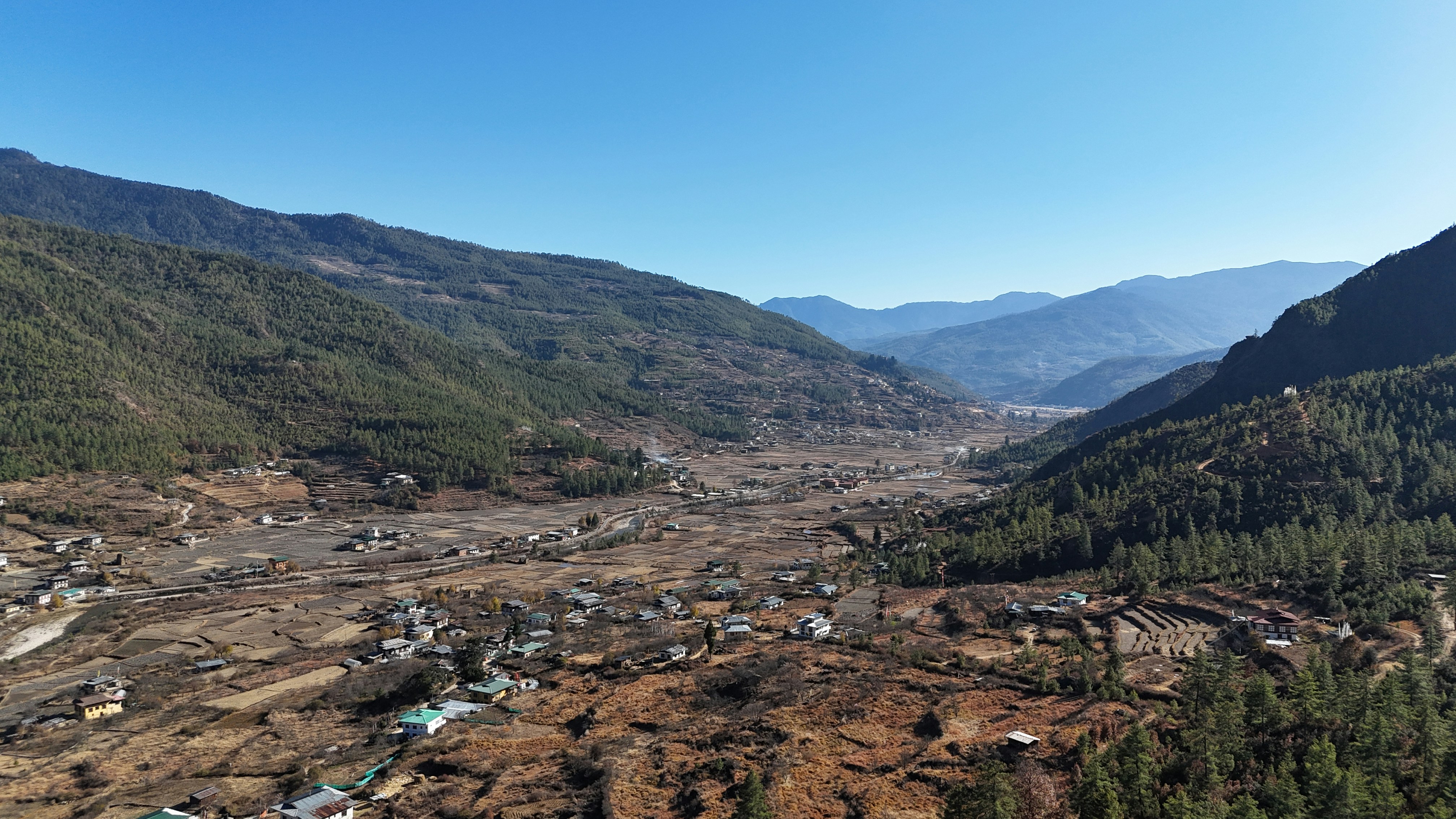 Valley Settlement Unfolding Through a Mountain Corrido