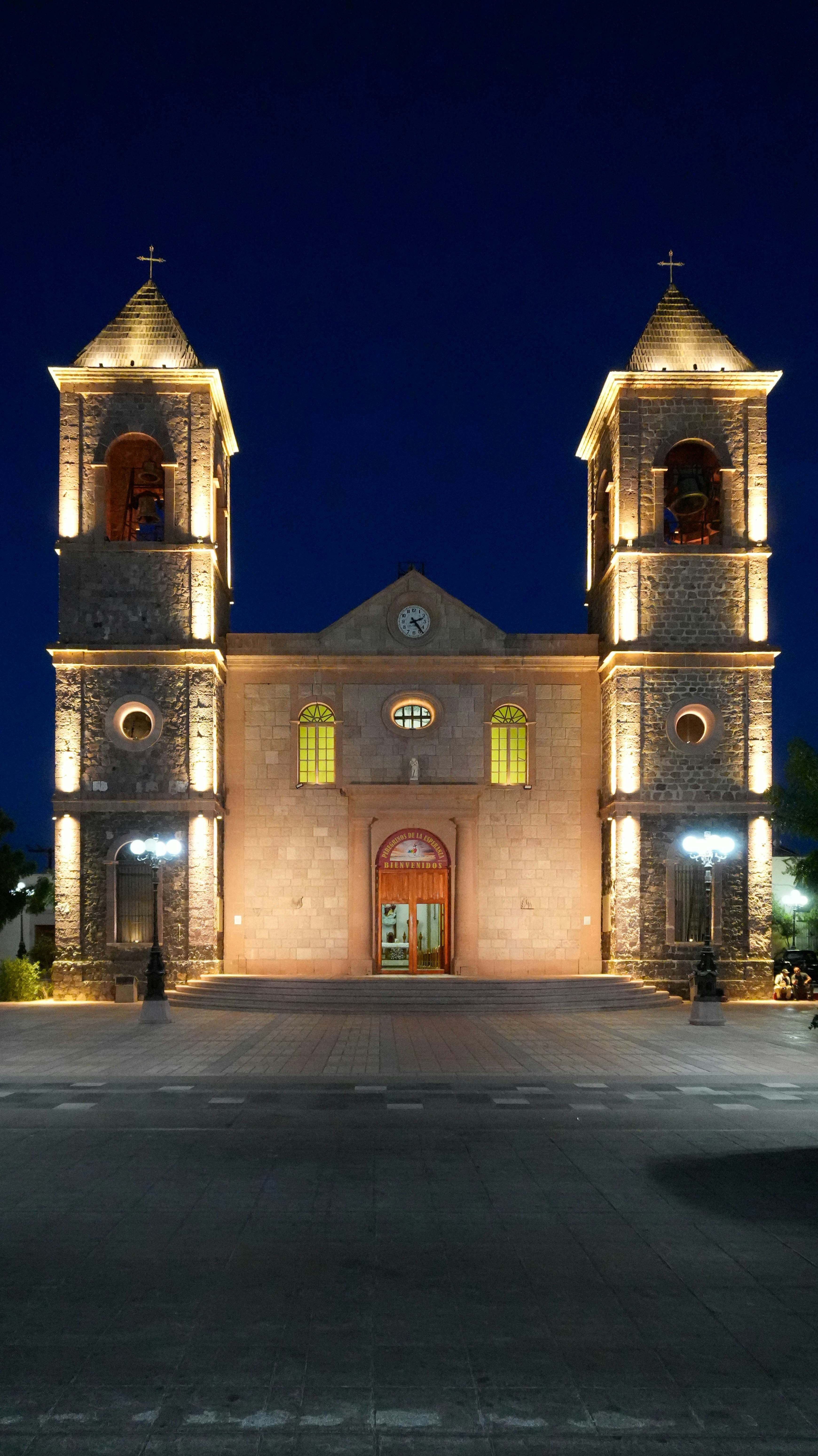 Night Cathedral Gates: Illuminated twin towers Stand Bold Over Quiet Plaza